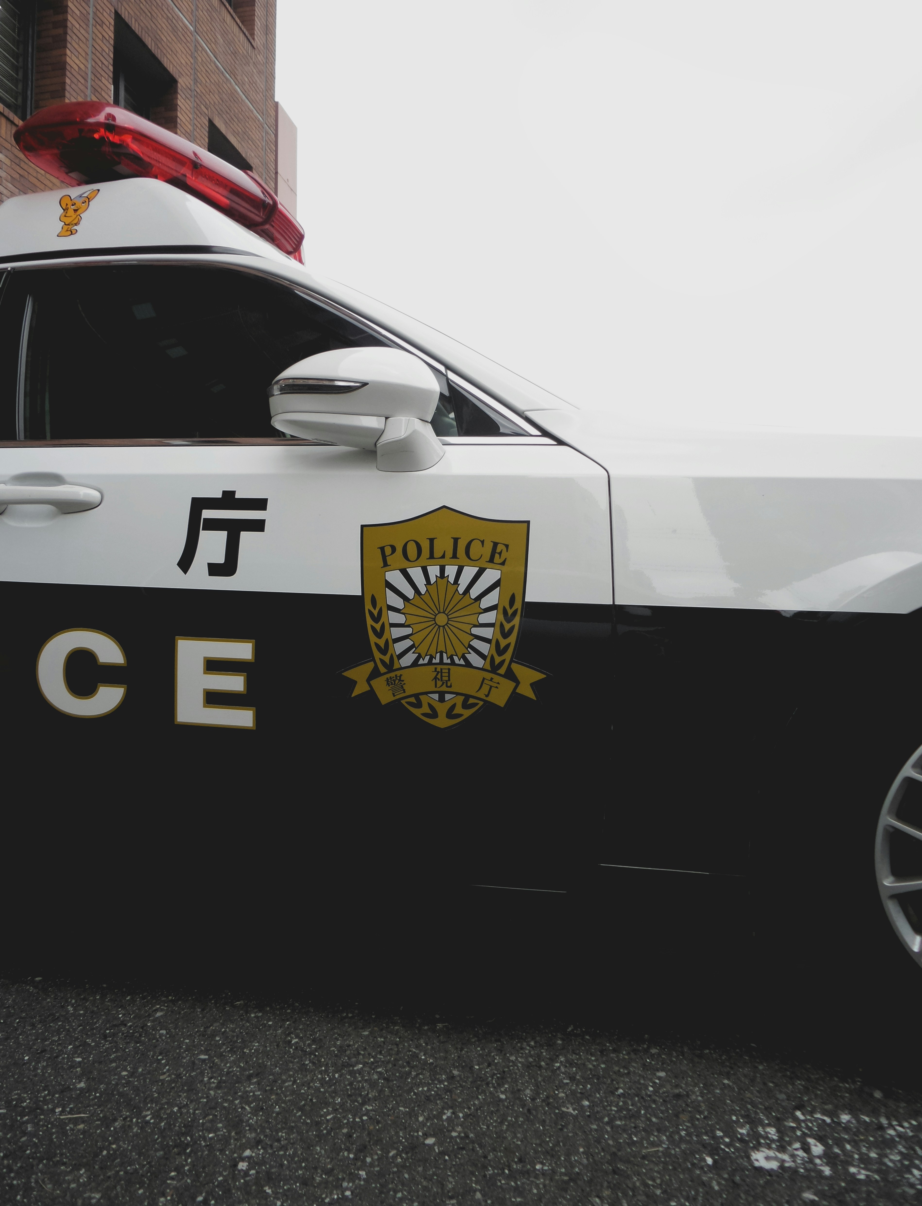 Side view of a police vehicle showcasing its distinctive markings and emergency lights.