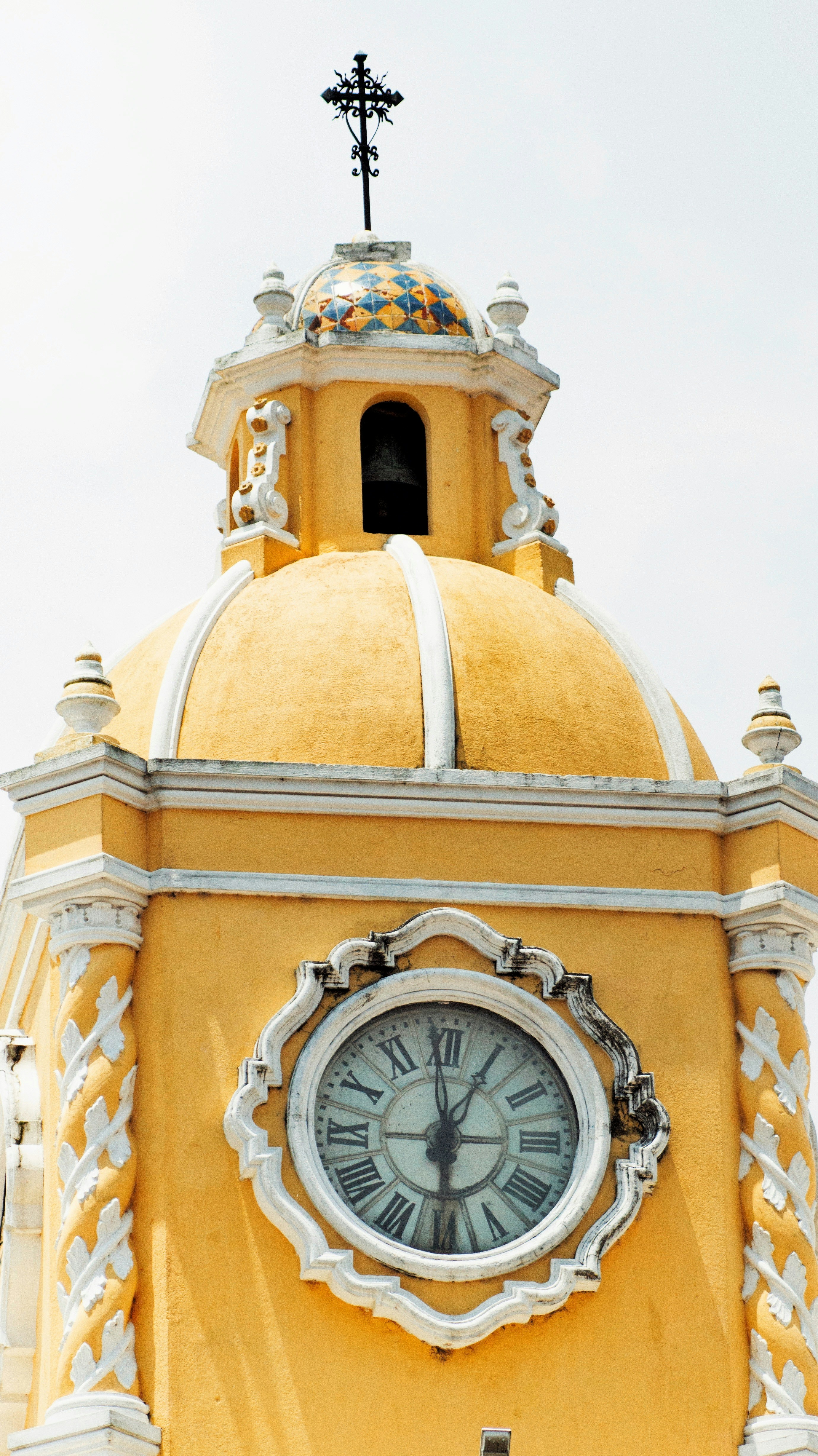 A large yellow clock tower with a cross on top photo – Free Antigua ...