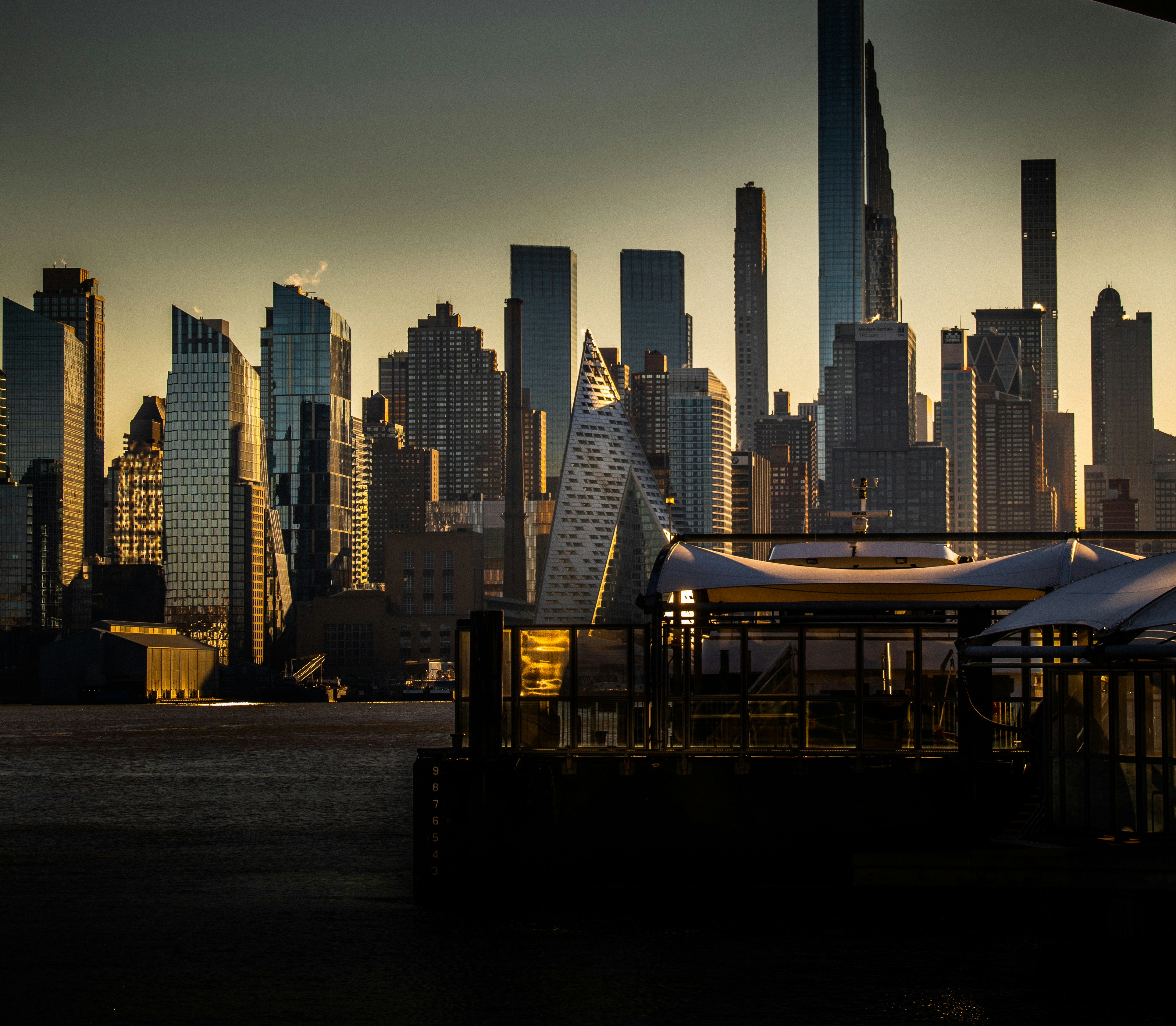 Triangular Peak Amid the Dusk Skyline Over a Quiet Harbor