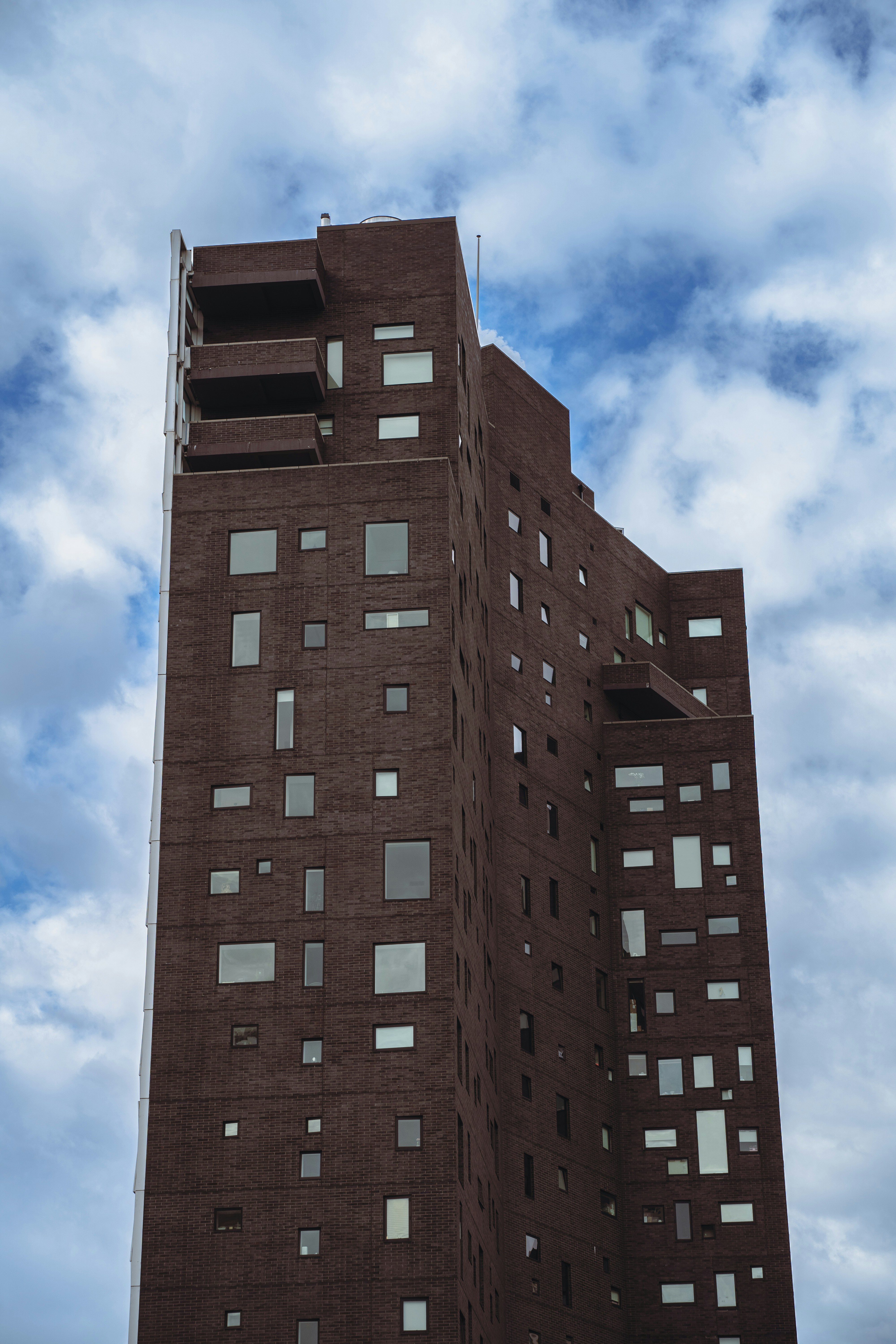 A tall brown building with lots of windows photo – Free Building Image ...