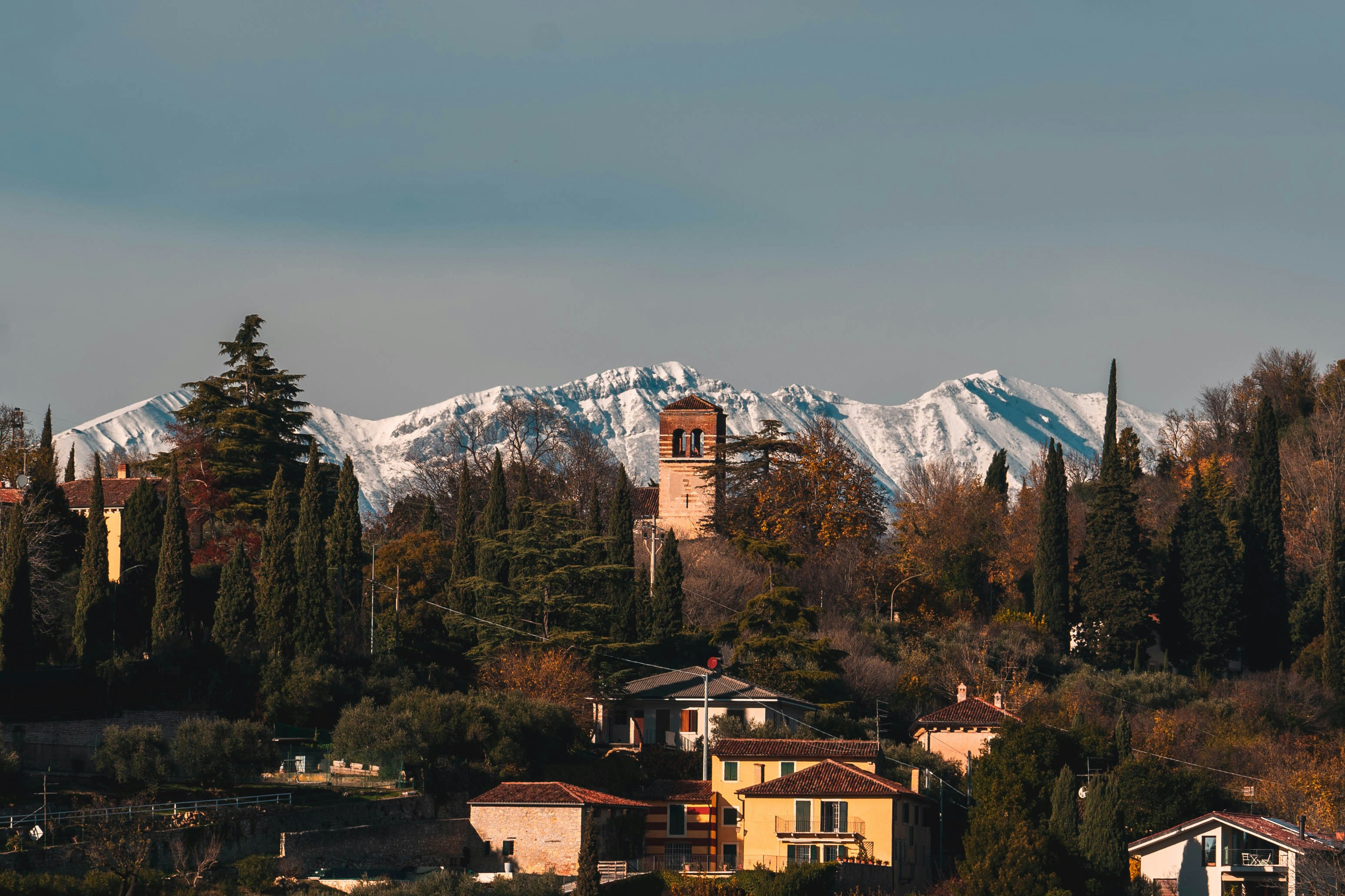 Snowy Peaks over a Tuscan-style Village