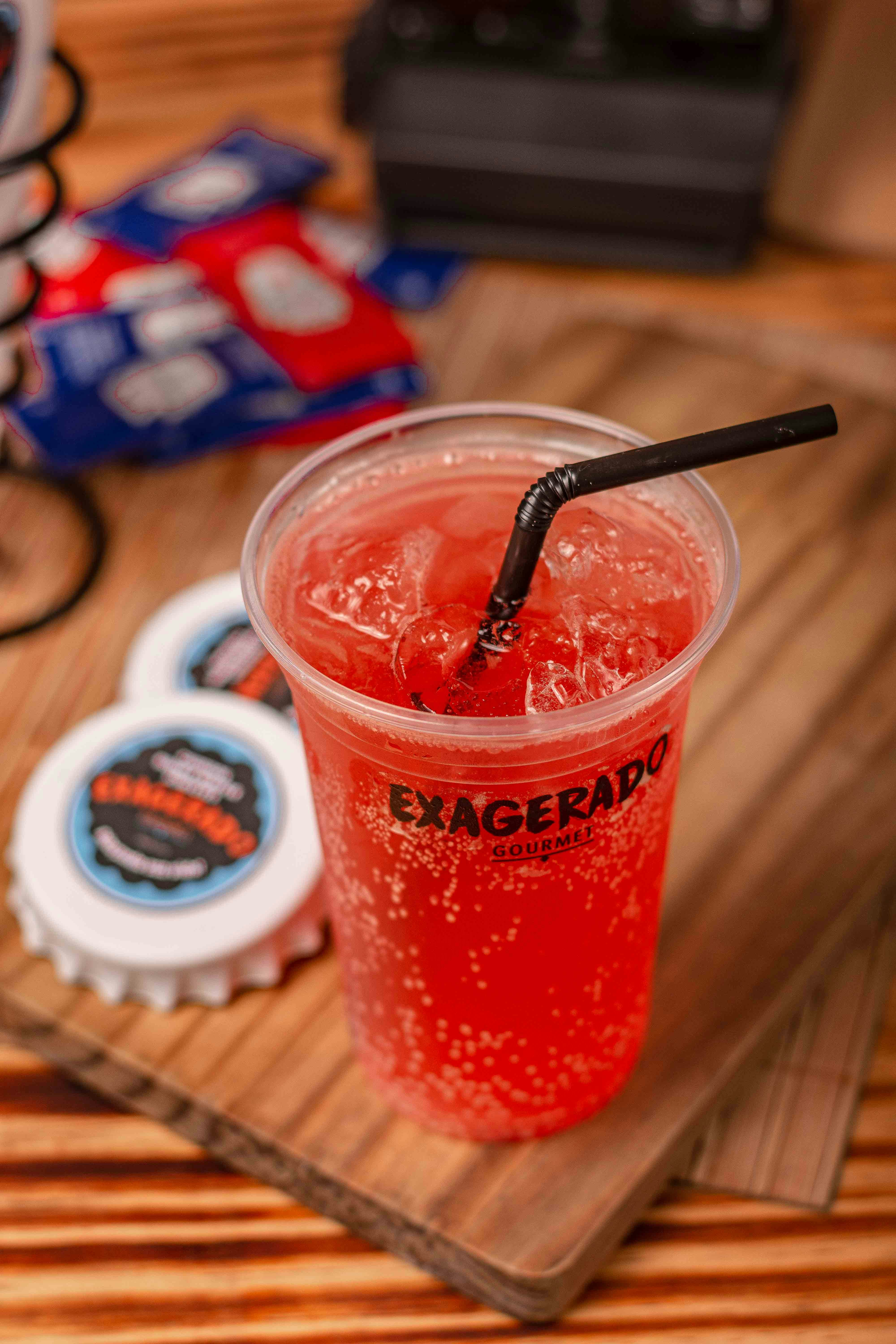 Crimson Spark: Ice-Cooled Drink on a Rustic Wood Board