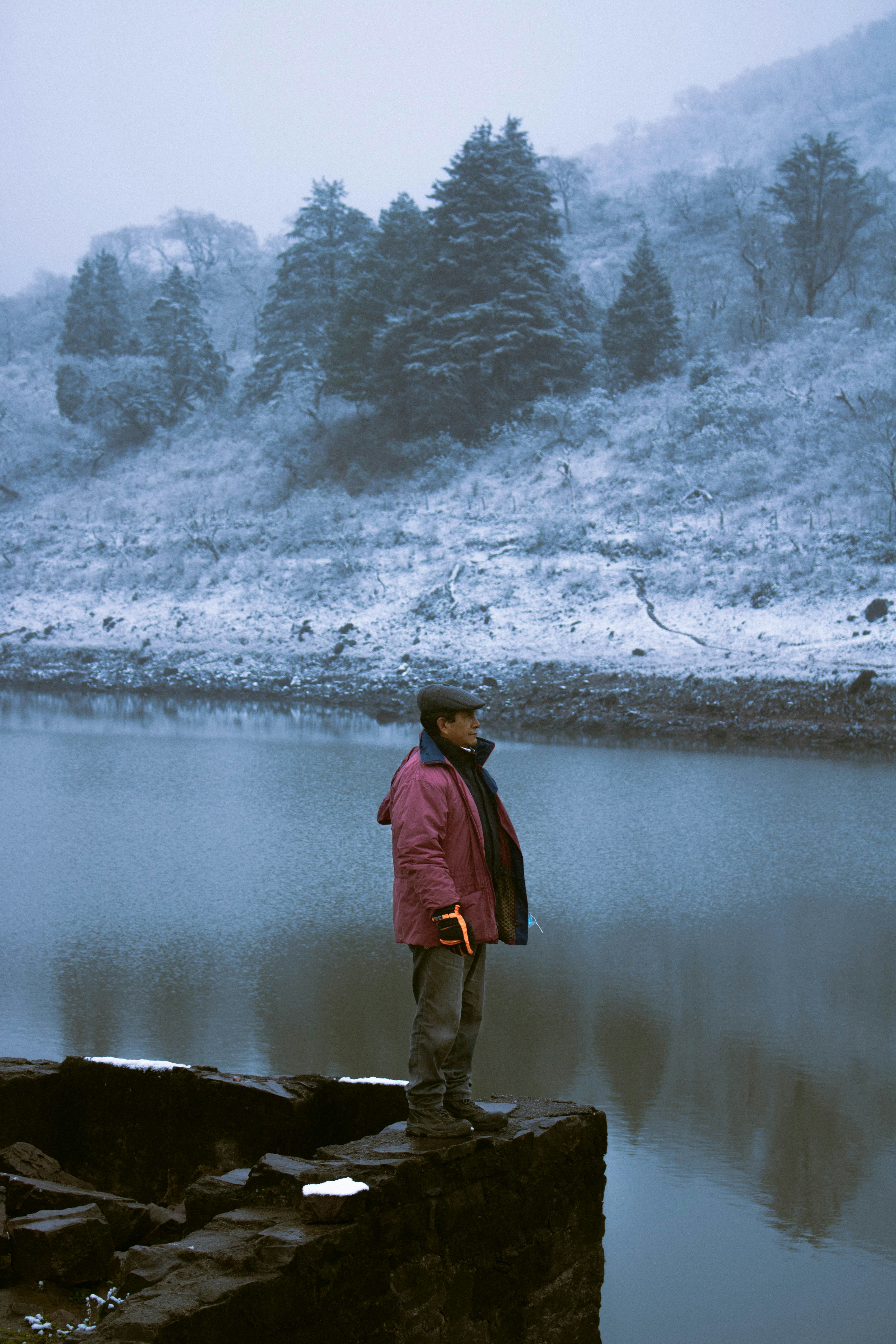 Red Jacket at the Snow-Frosted Lake's Edge
