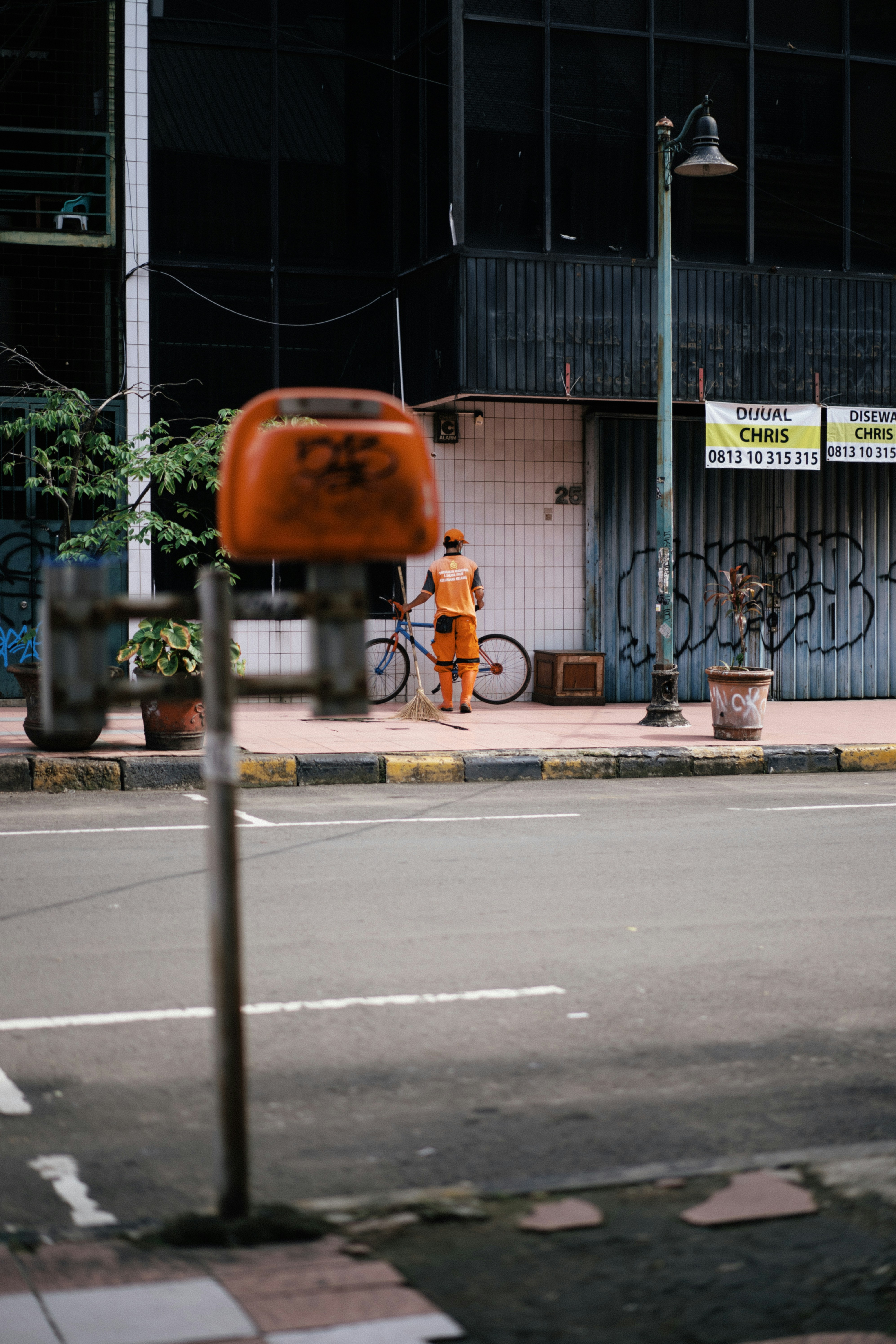 Orange Worker Stance on Quiet City Street at Dusk
