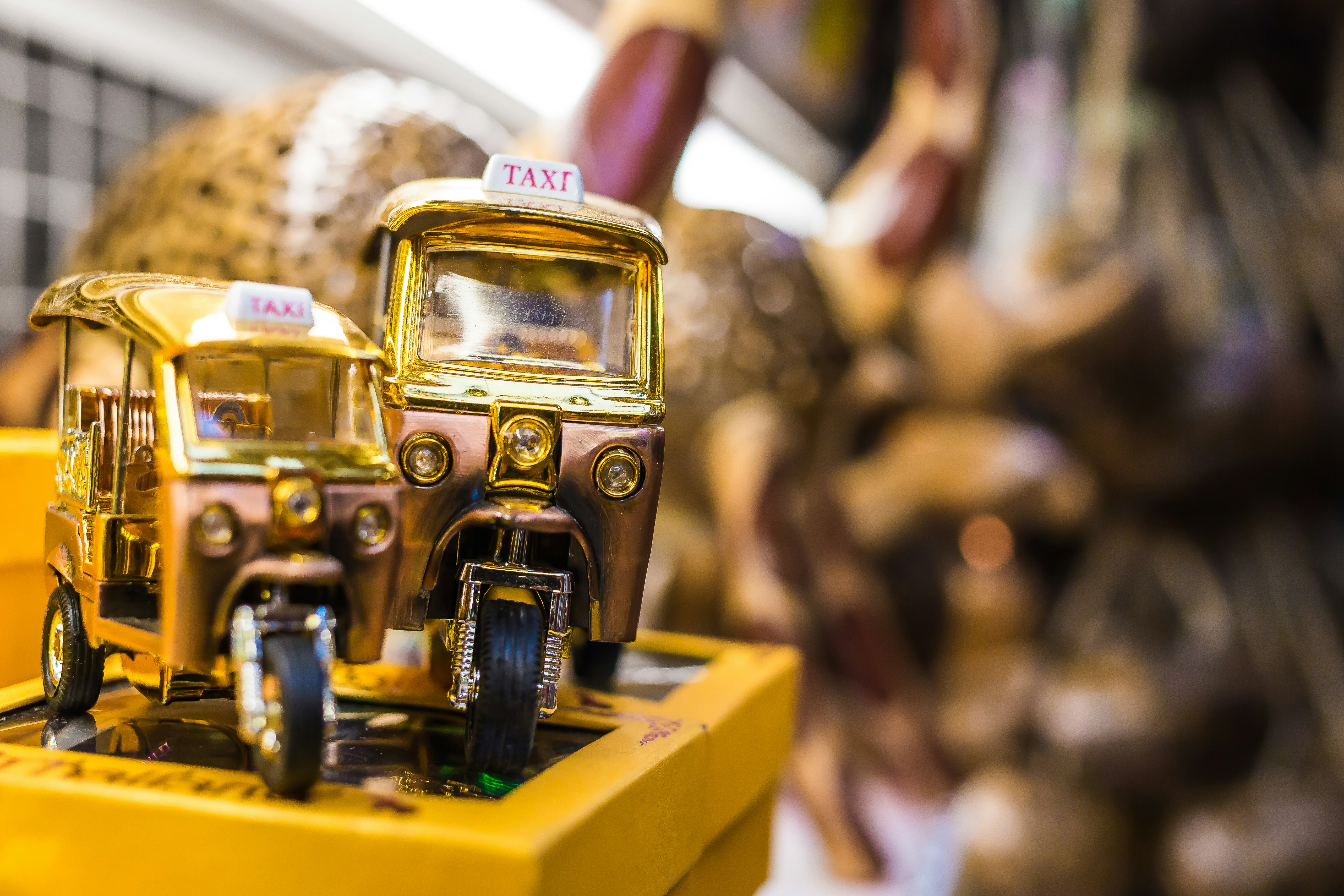 Miniature Taxi Parade: Golden Toy Taxis on a Bright Street