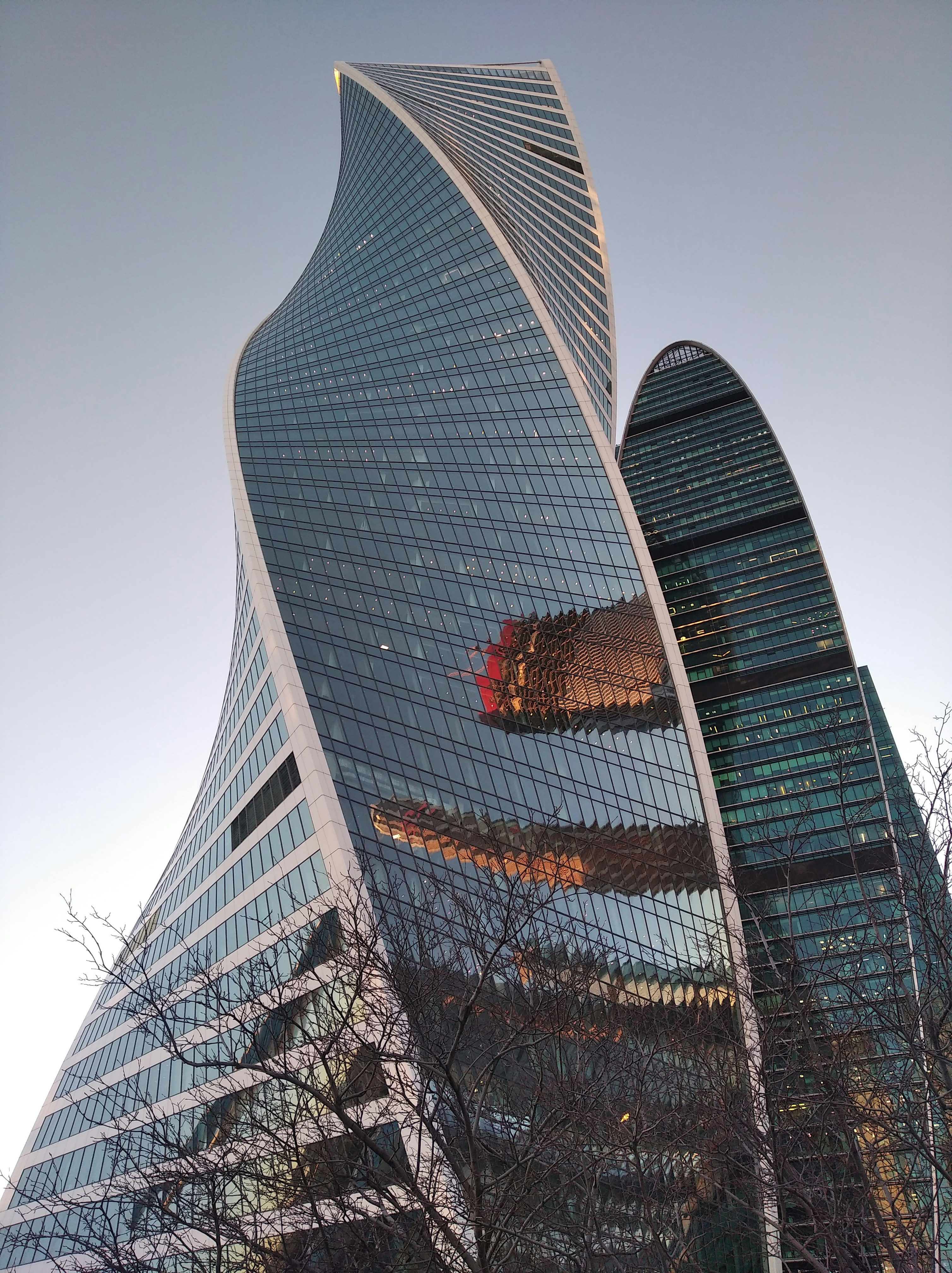 A very tall building with a very curved roof photo – Free Building ...