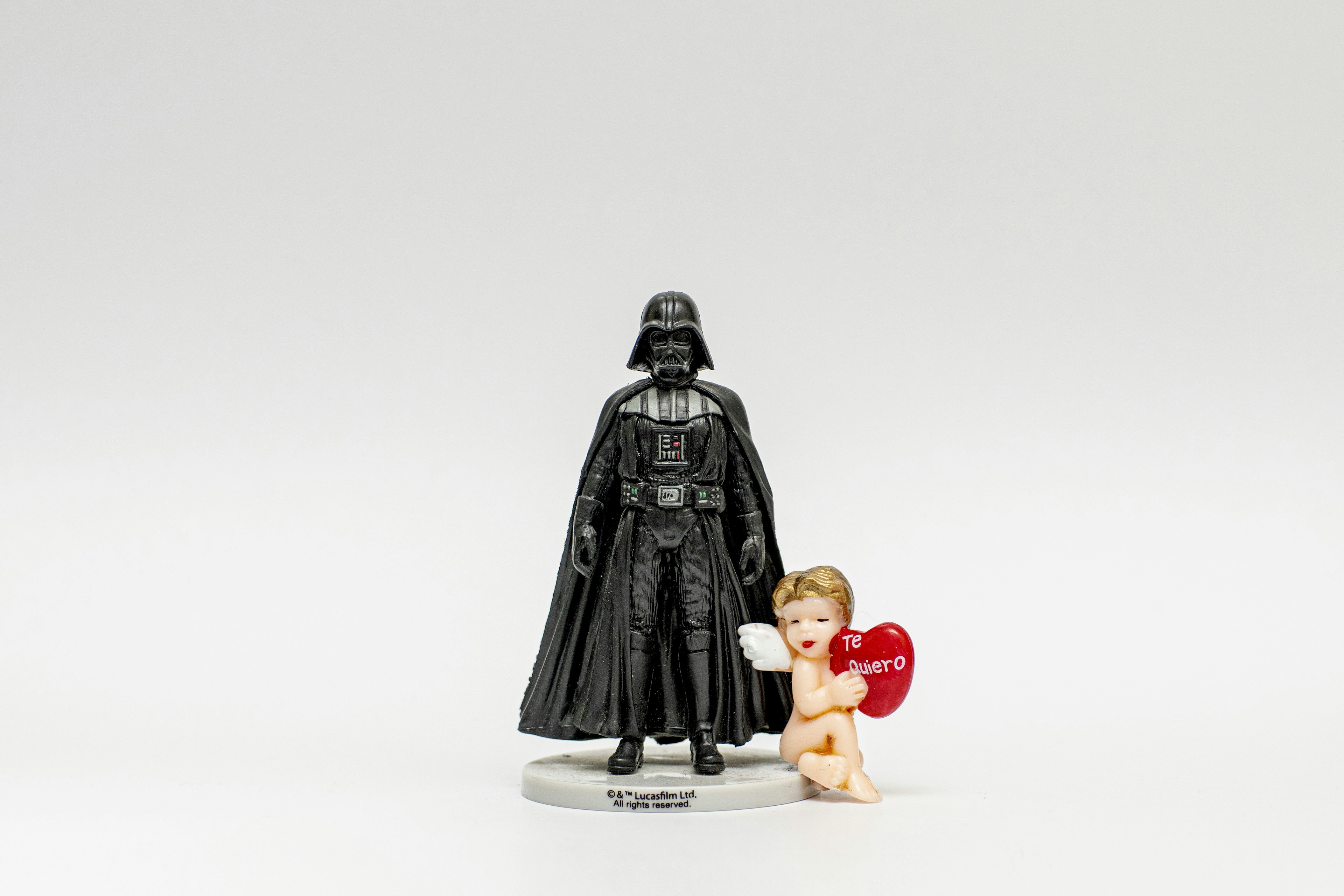 a star wars figurine is holding a heart