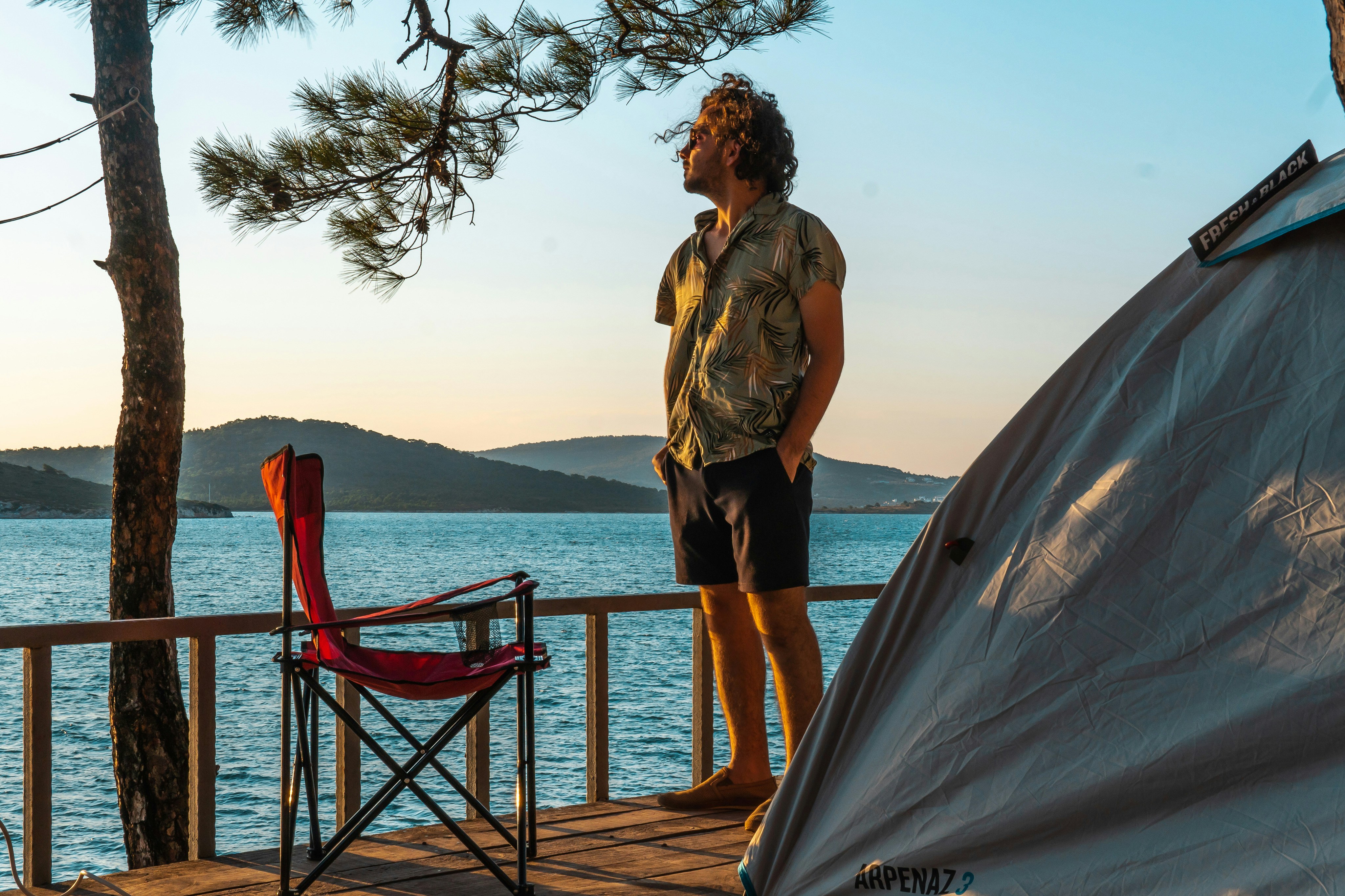 Lakeside Campout: Man at Dusk Beside a Tent