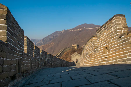 a view of the great wall of china with mountains in the background