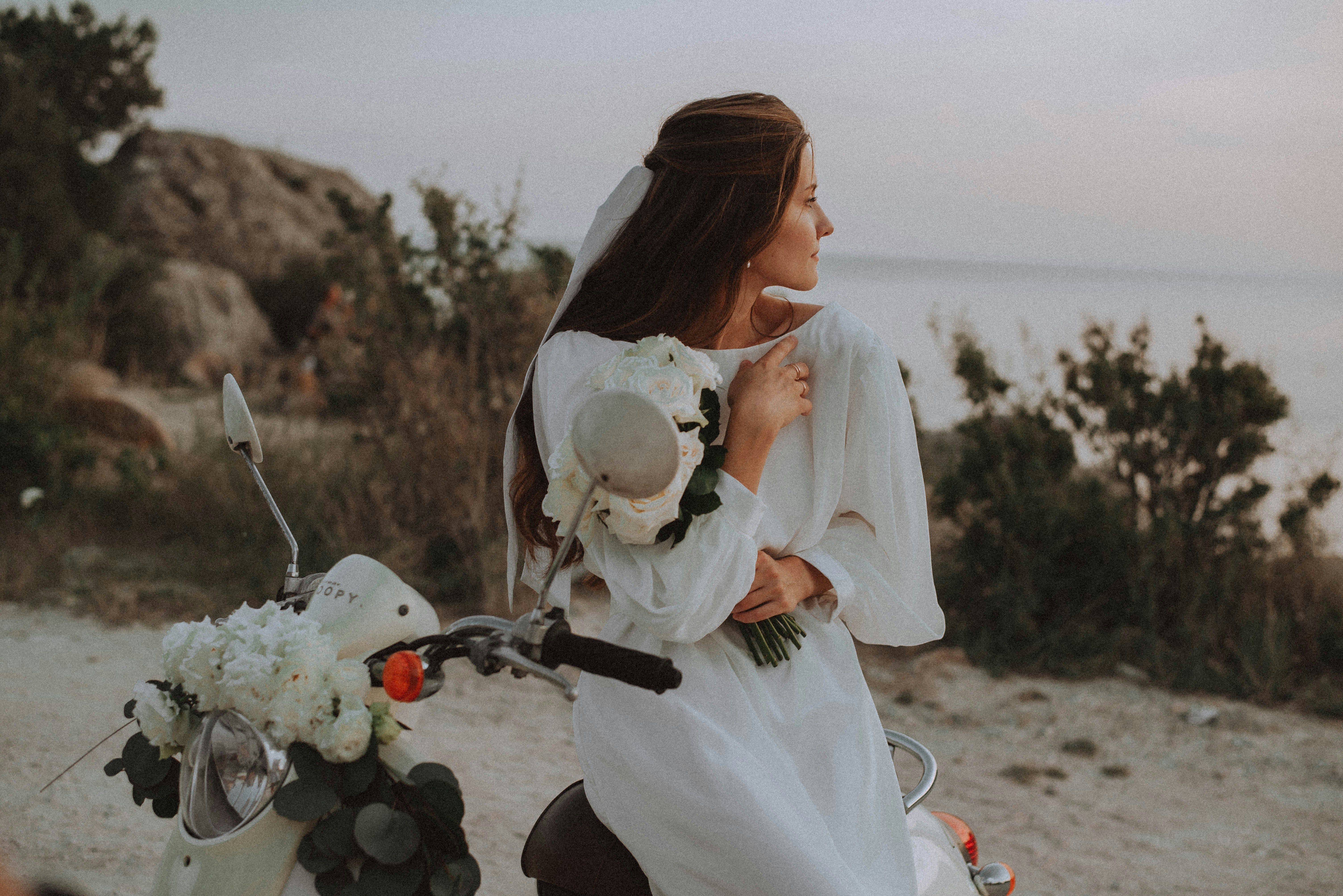 Bloom-Crowned Bride on a Coastline Scooter