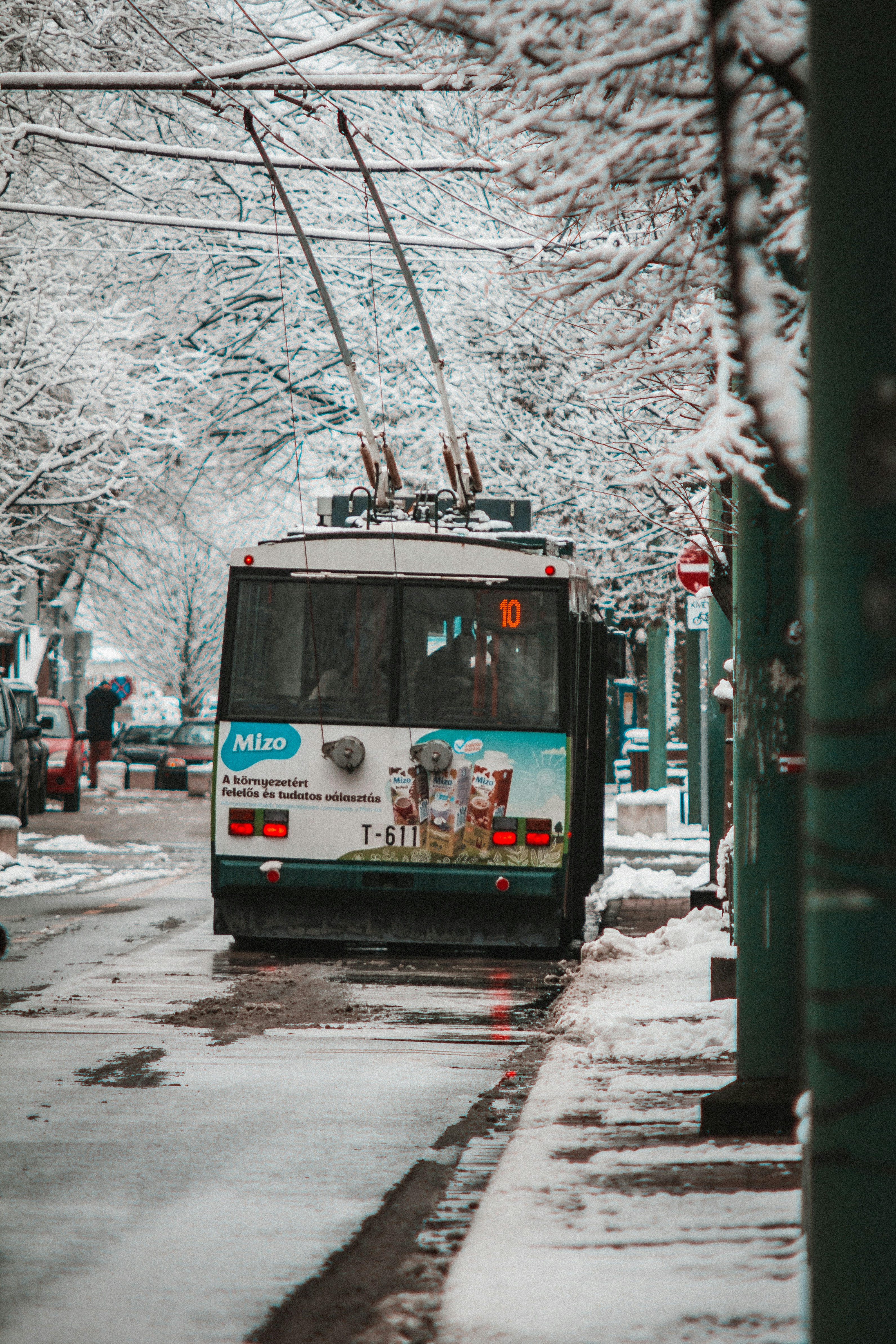 a bus driving down a snow covered street
