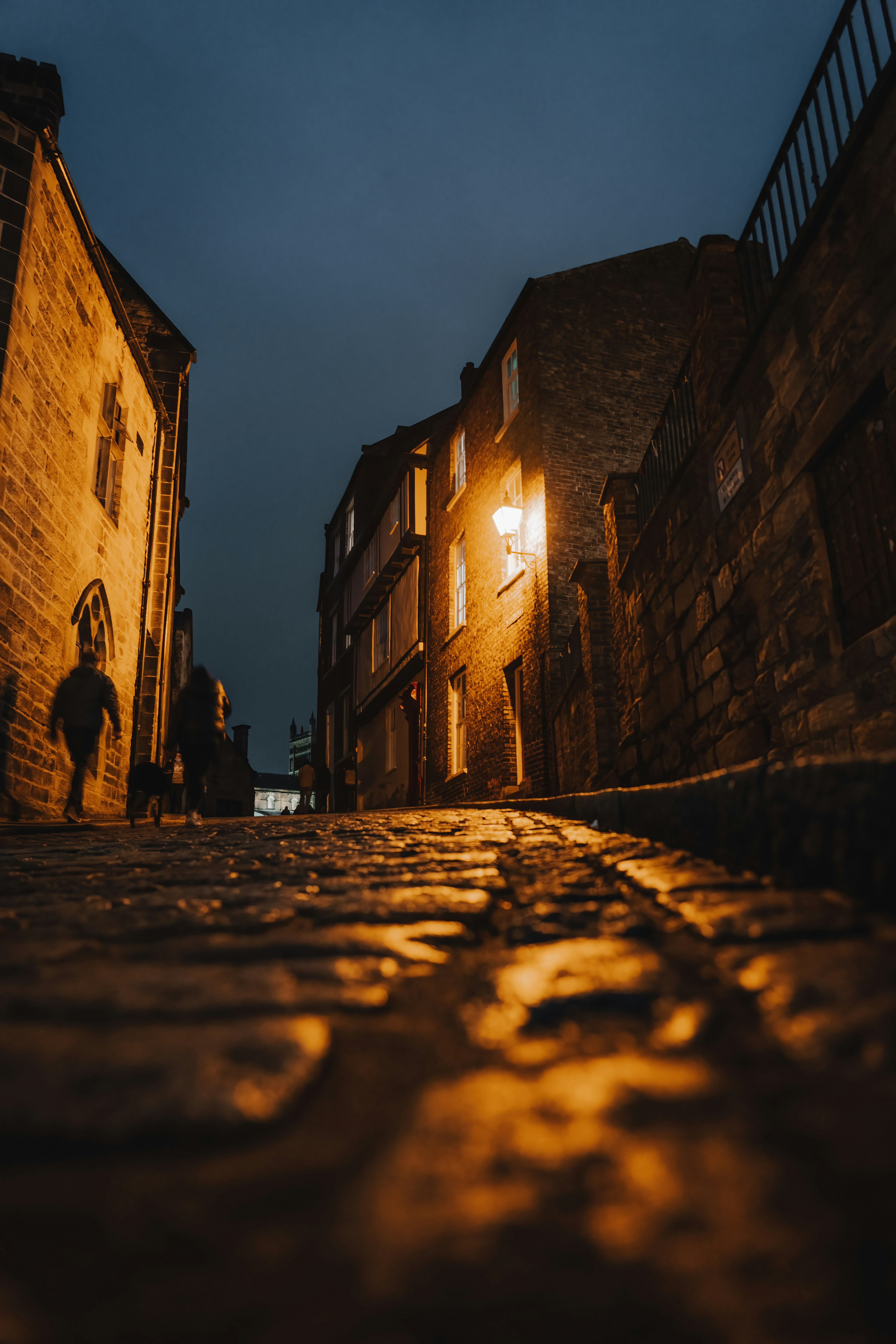 A cobblestone street at night with a light on photo – Free Durham Image ...