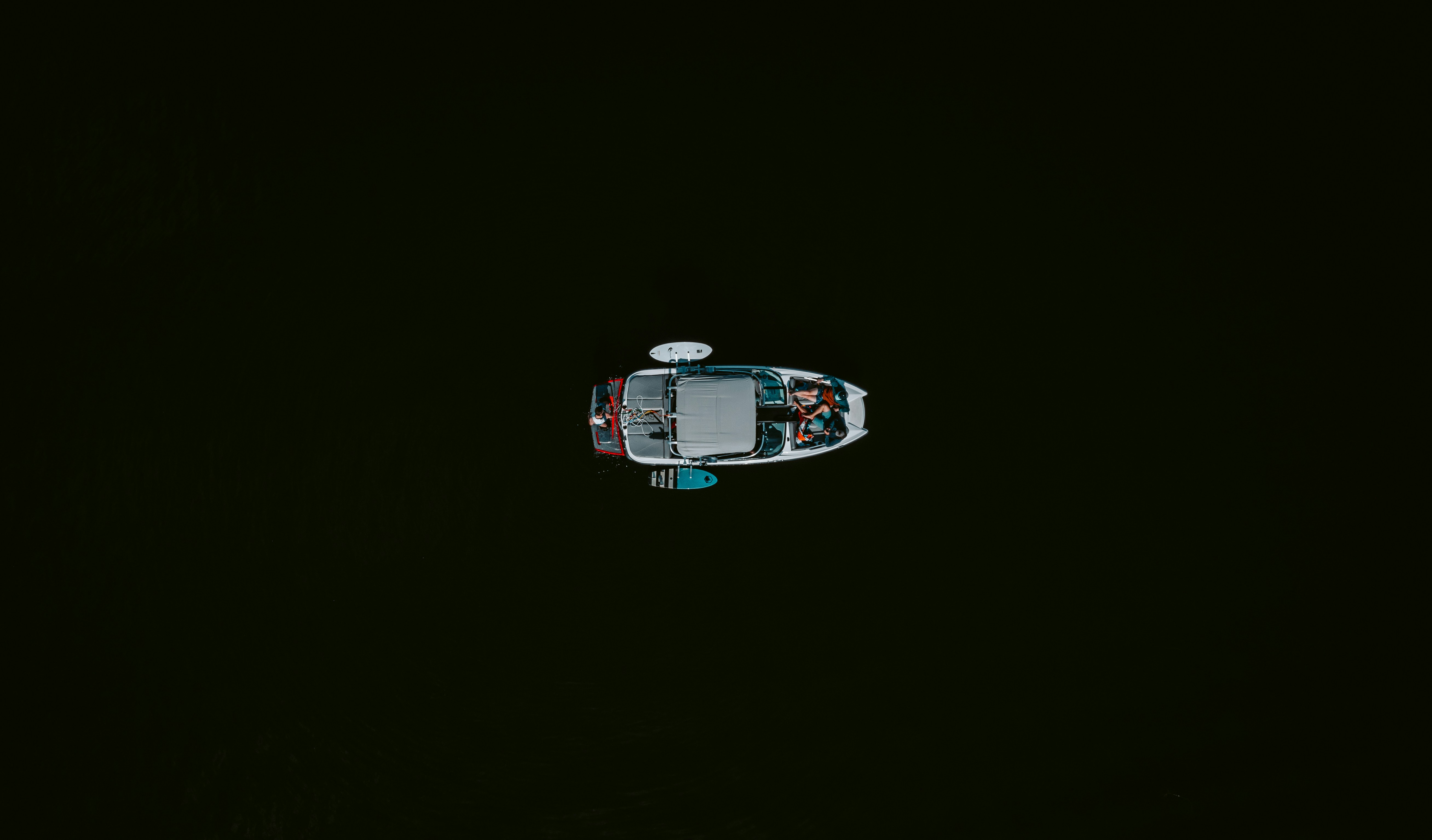 An overhead view of a small boat in the water photo – Free Dji Image on ...