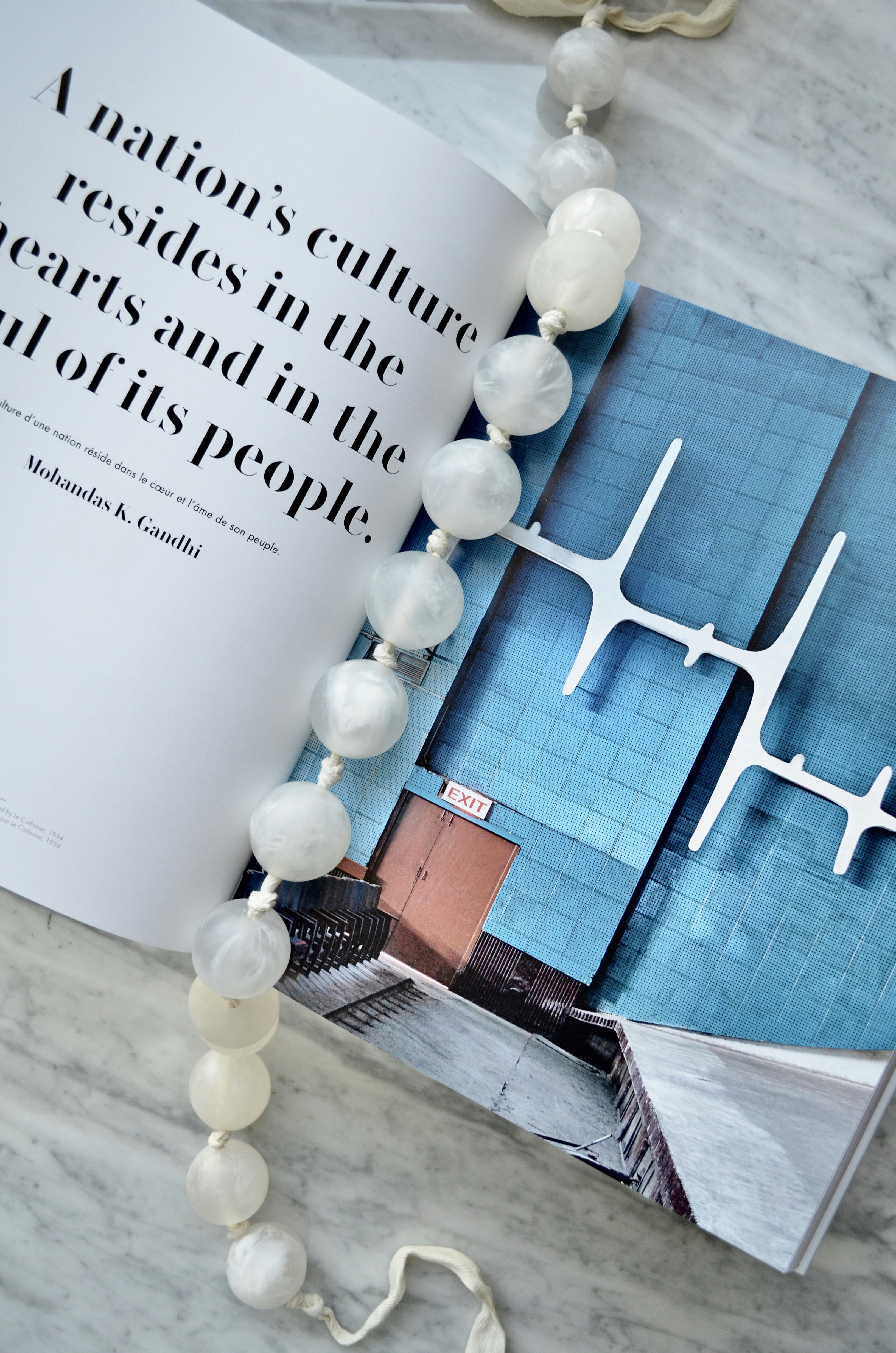 Pearl Necklace Crossing a Blue Architectural Spread