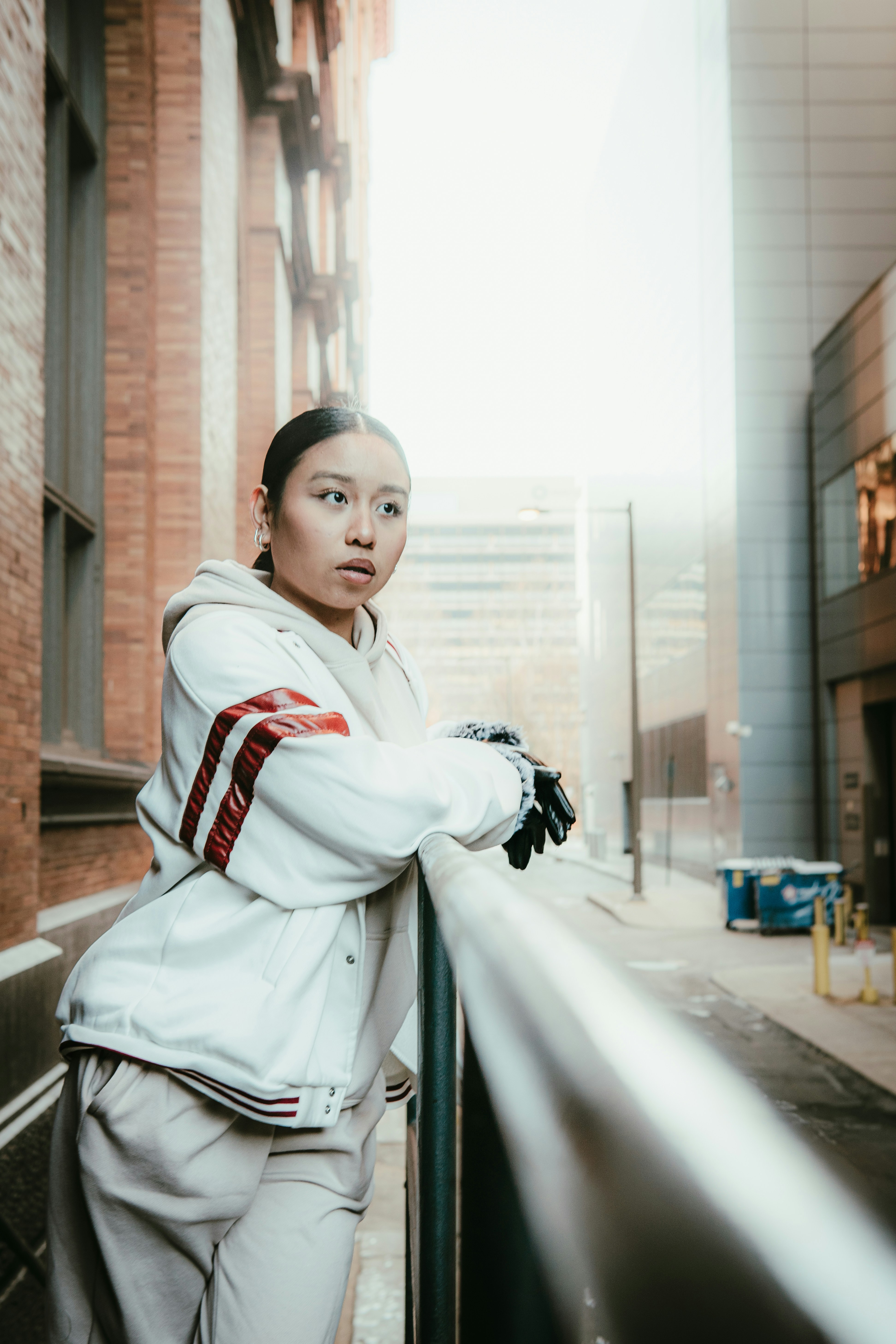 Edge of the Alley: A Quiet Portrait Against City Railings