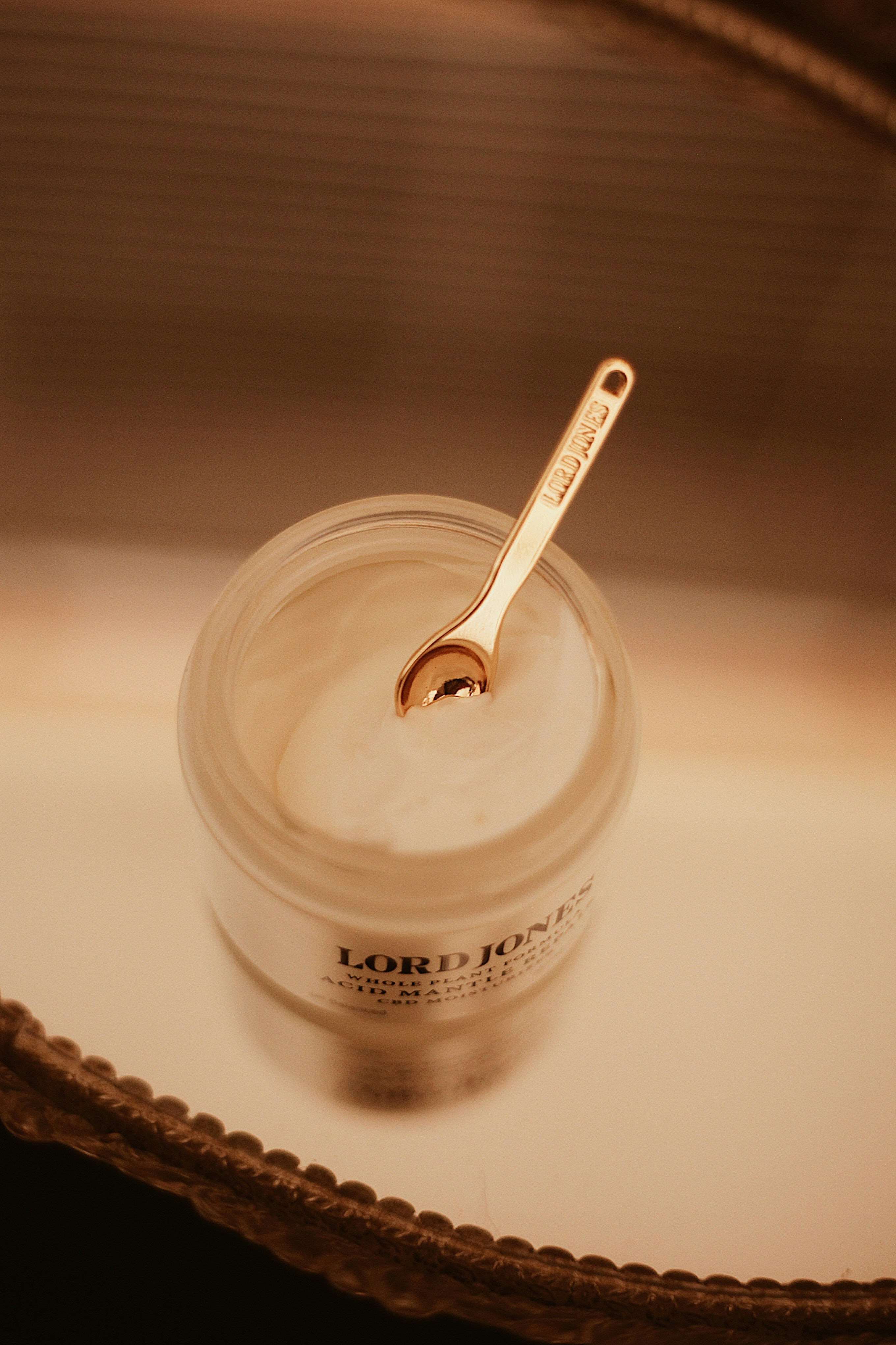 a jar of cream with a spoon sticking out of it