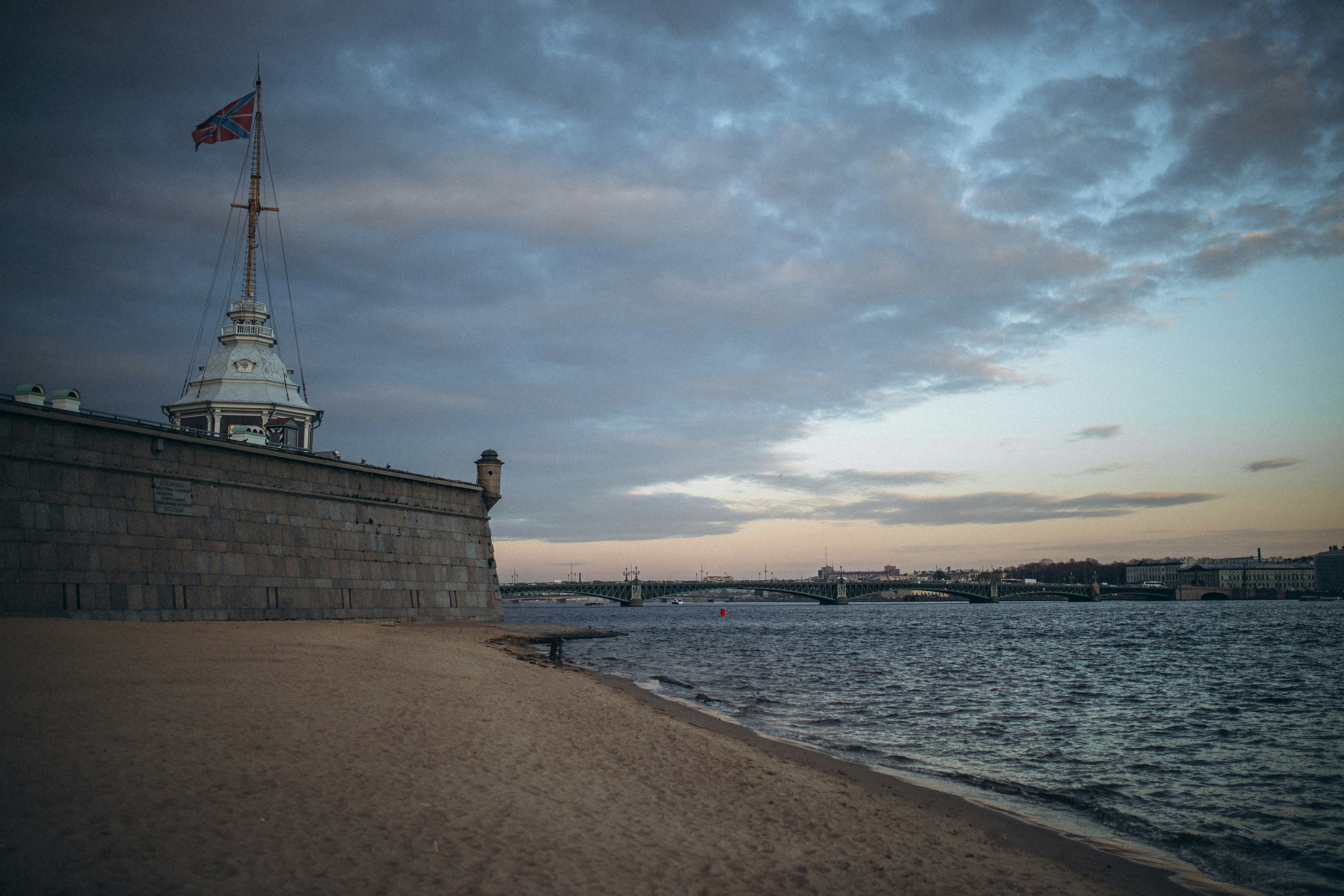 Dusk at the Quay: Flag-Topped Turret Over Quiet Water