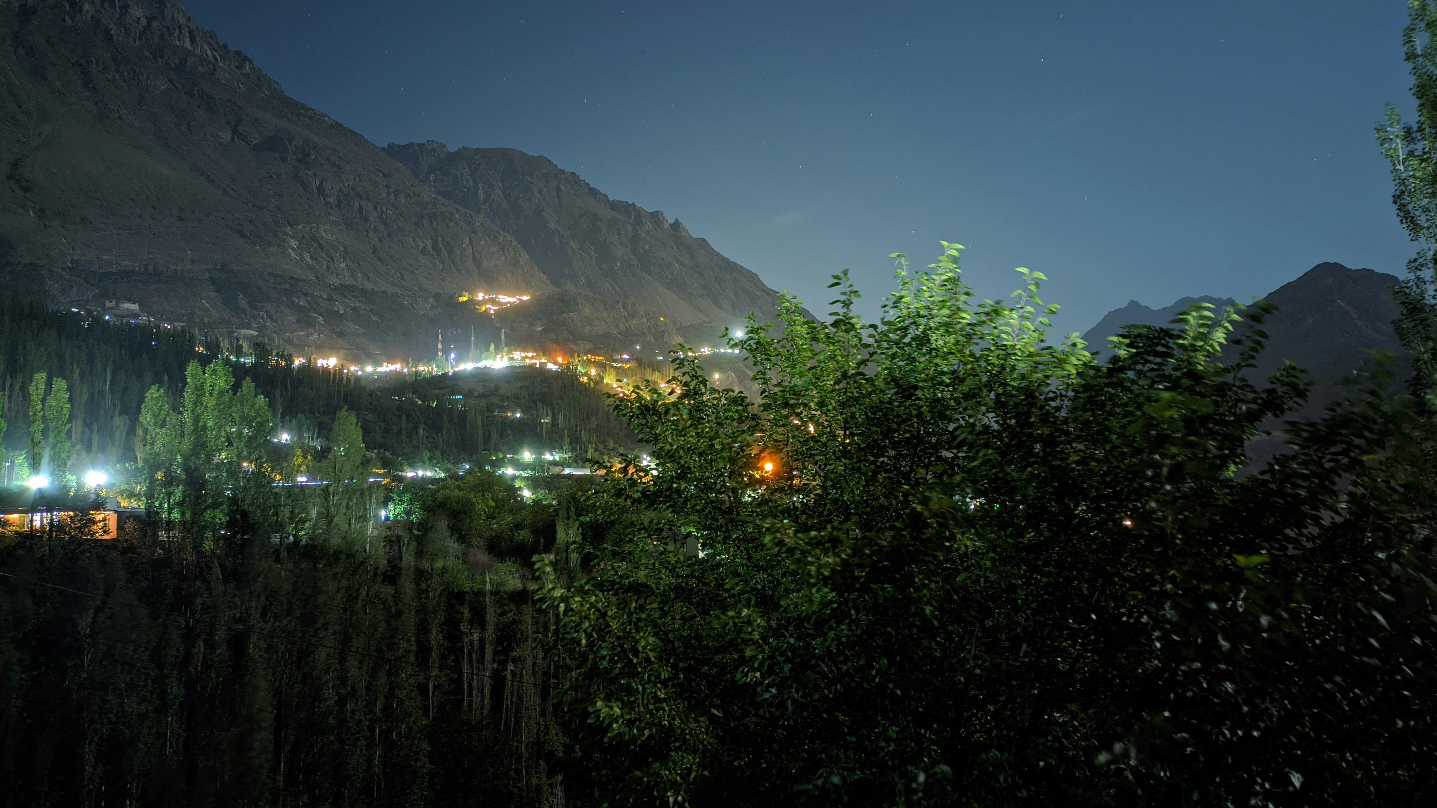 Valley Lights Under Moonlit Peaks