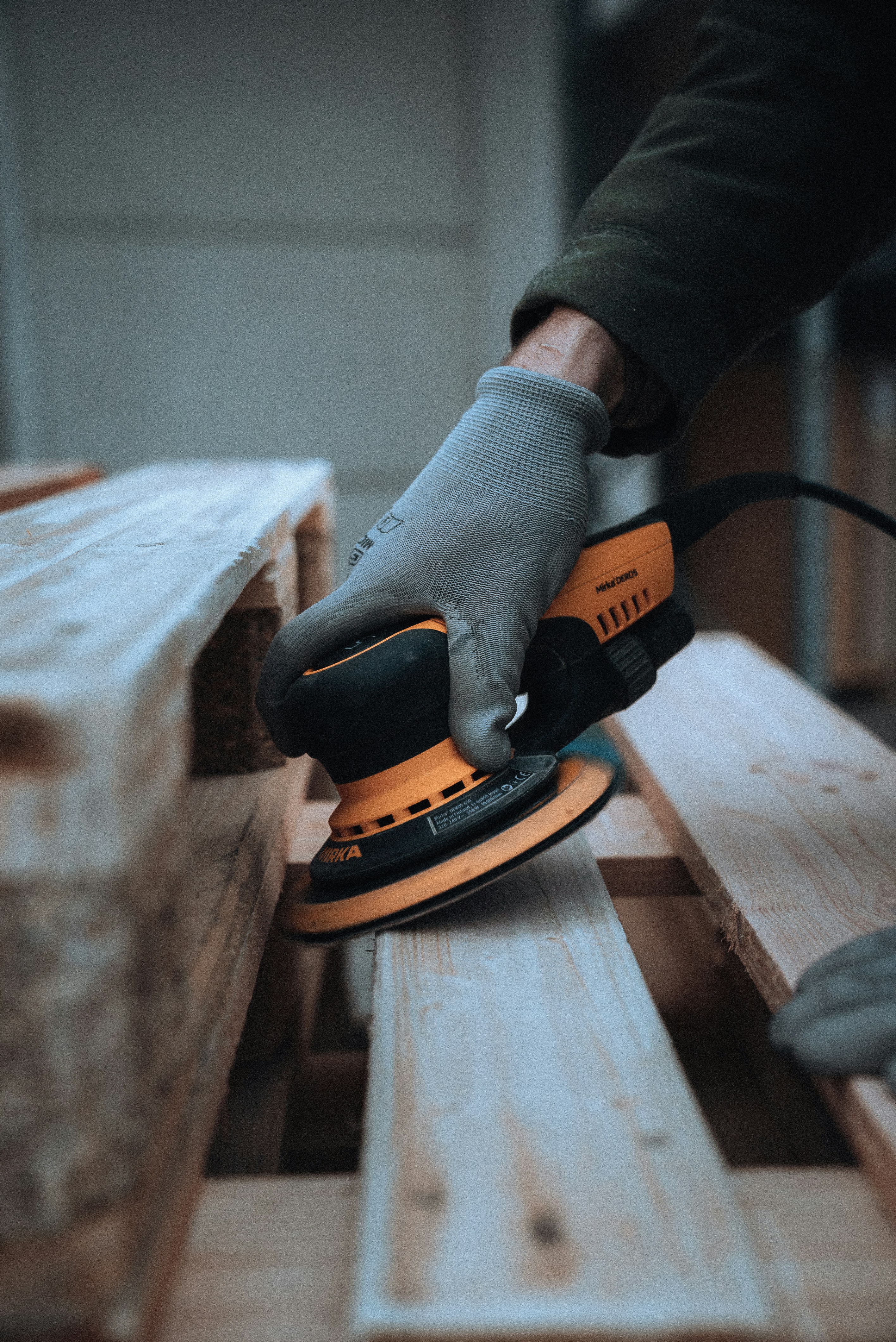 A person using a sander on a piece of wood photo – Free Wood Image on ...