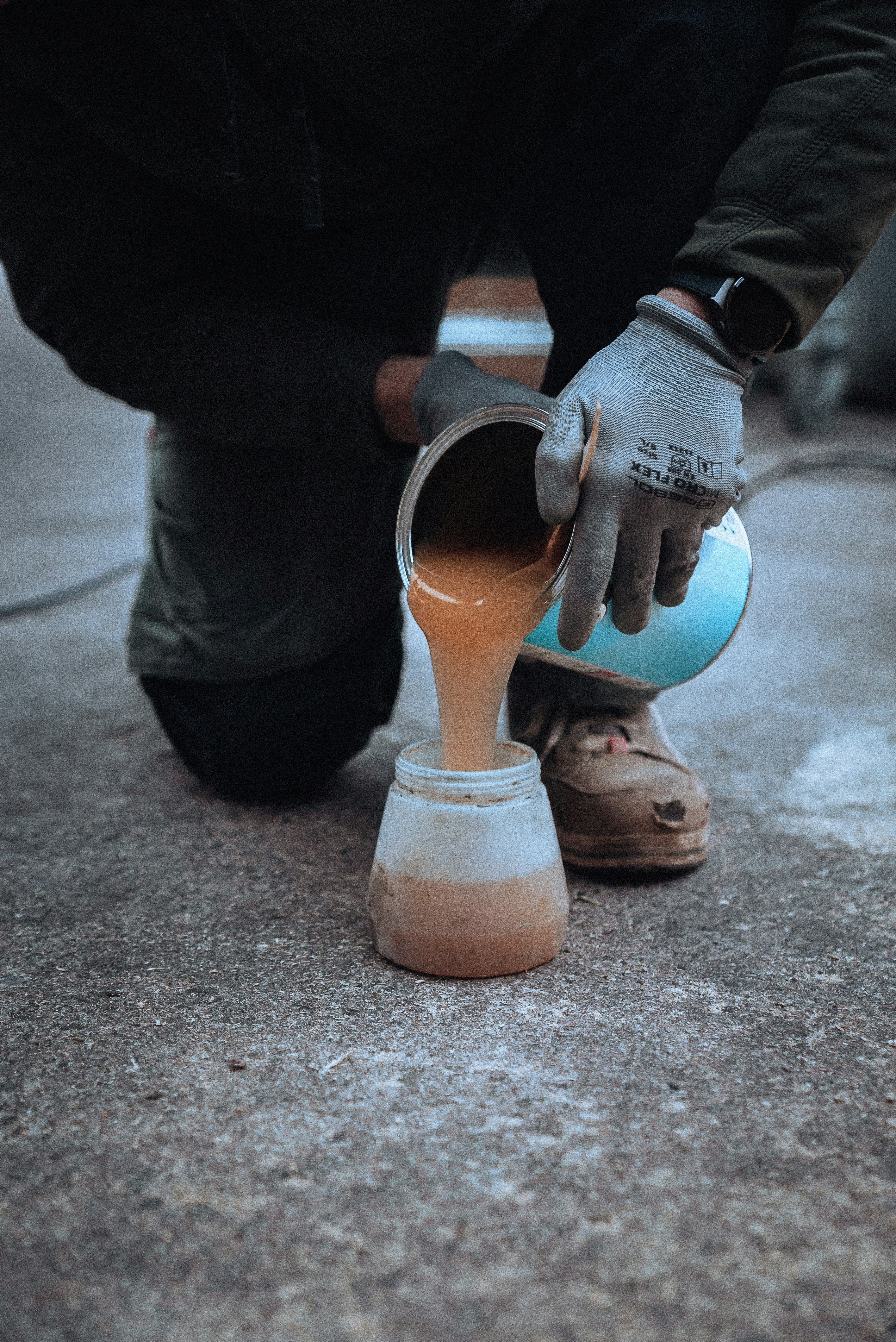 a person is pouring something into a cup