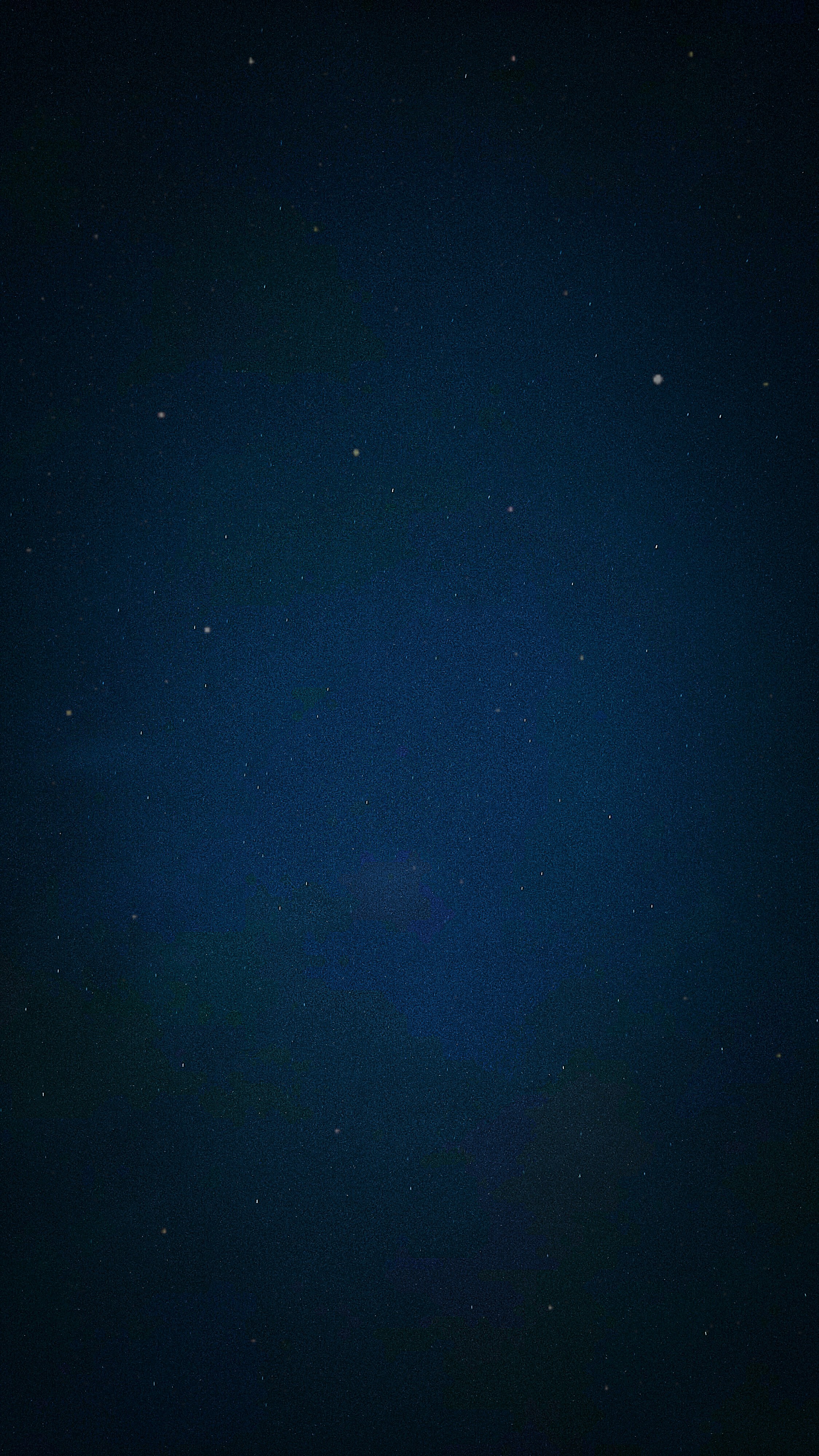 Starry night sky filled with scattered stars against a deep blue backdrop.