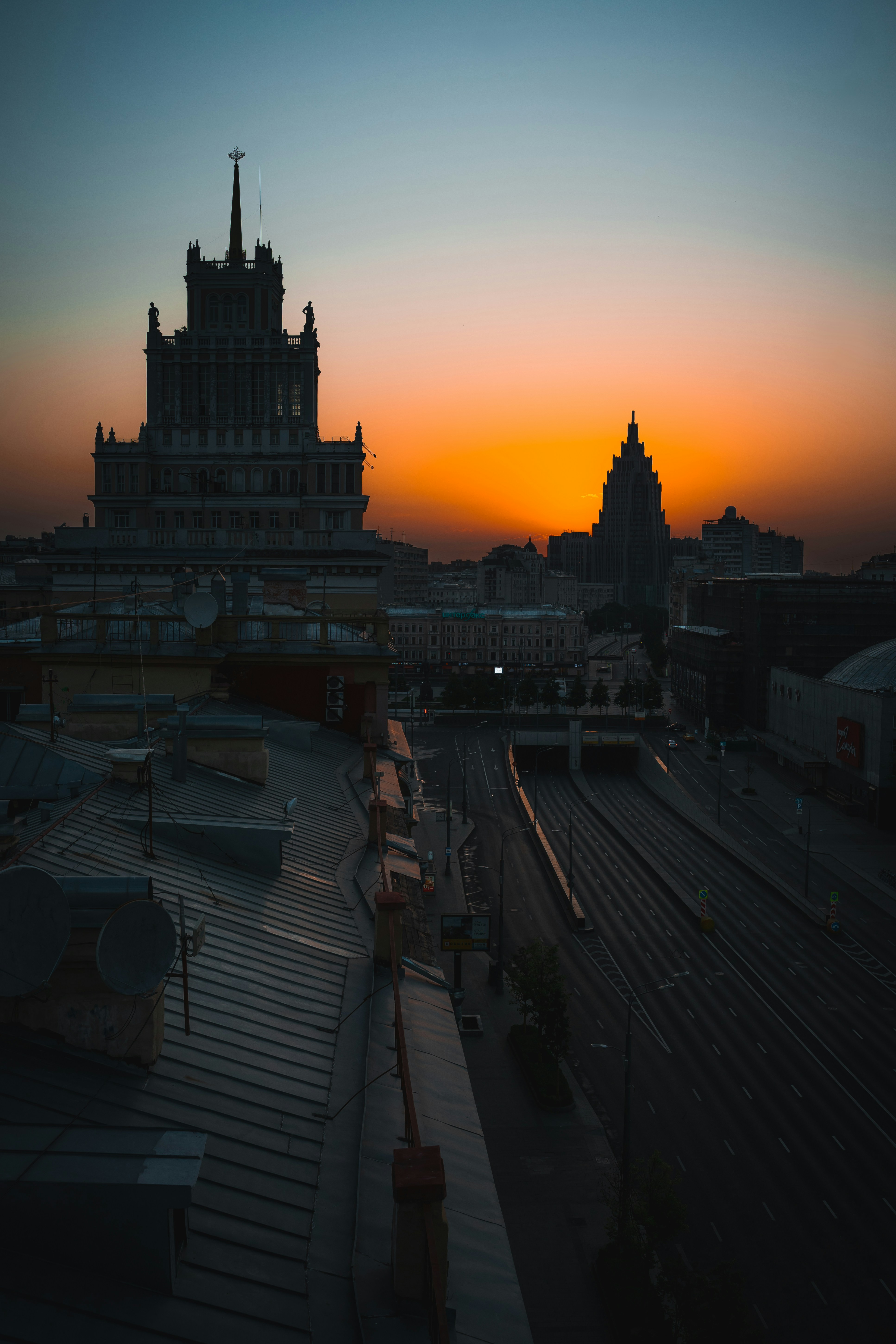 Sunset Over a Soviet-Style Skyline: Tower Silhouettes and Rail Axis