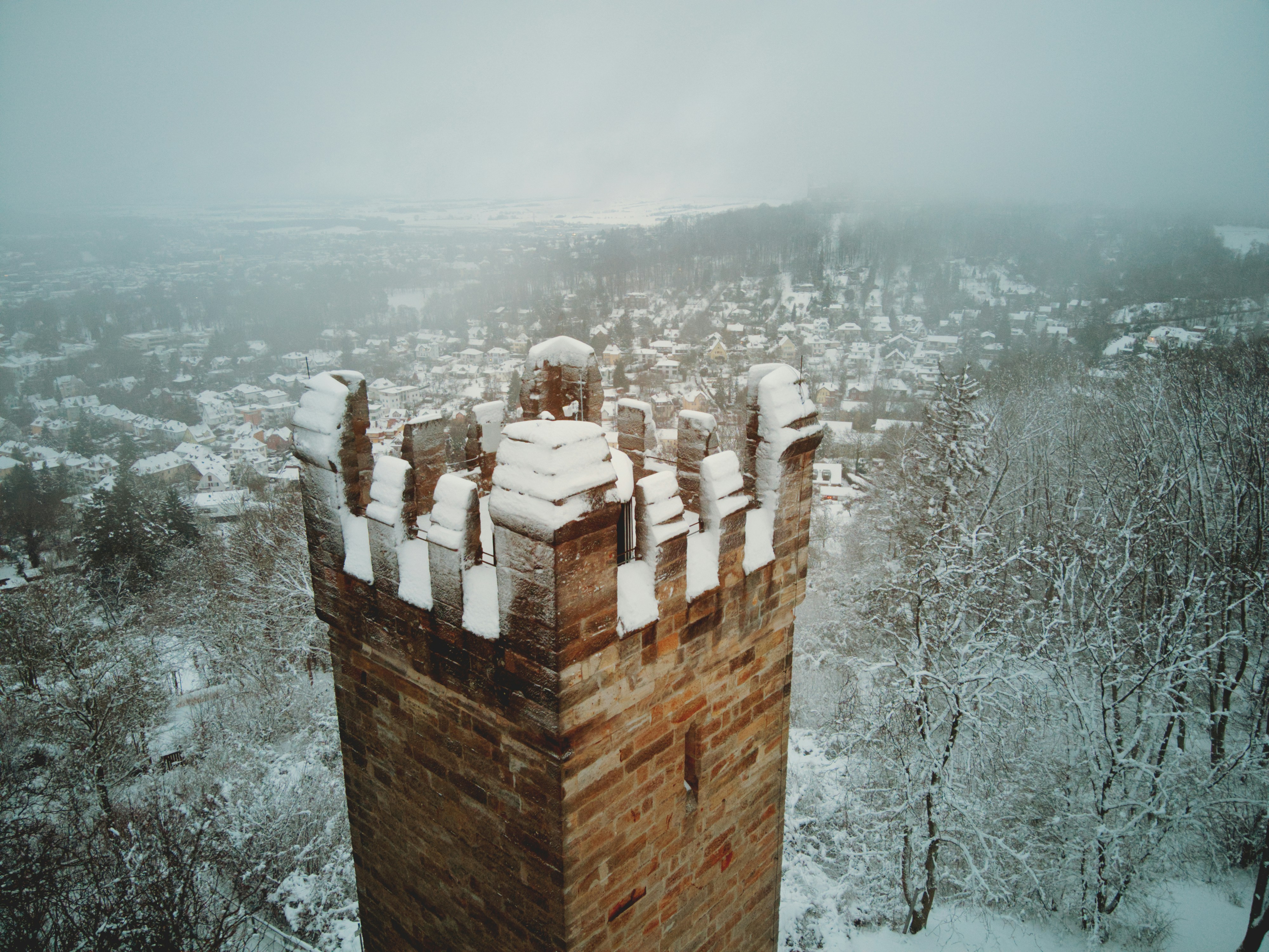 a view of a snowy city from a tower