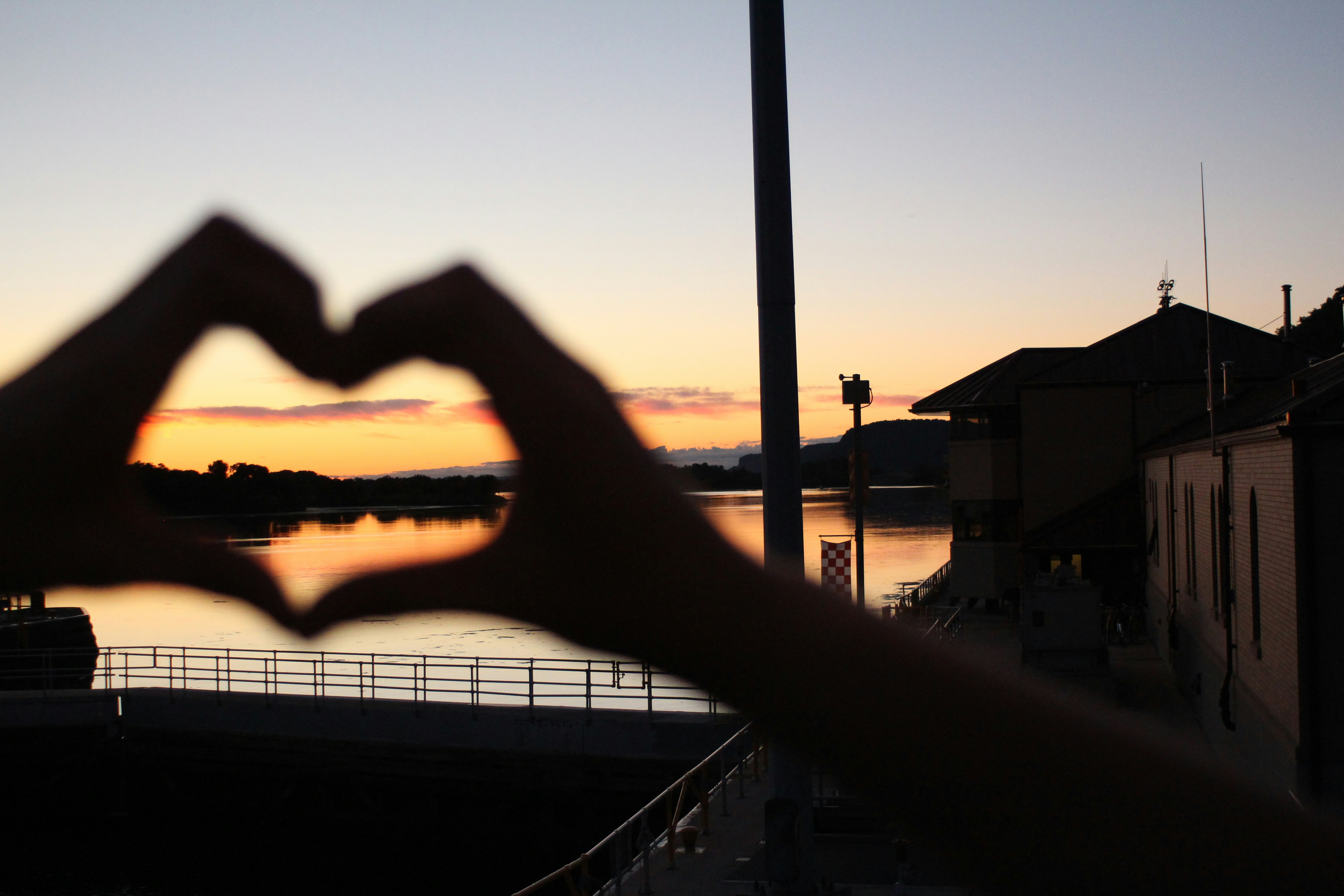 a person making a heart shape with their hands