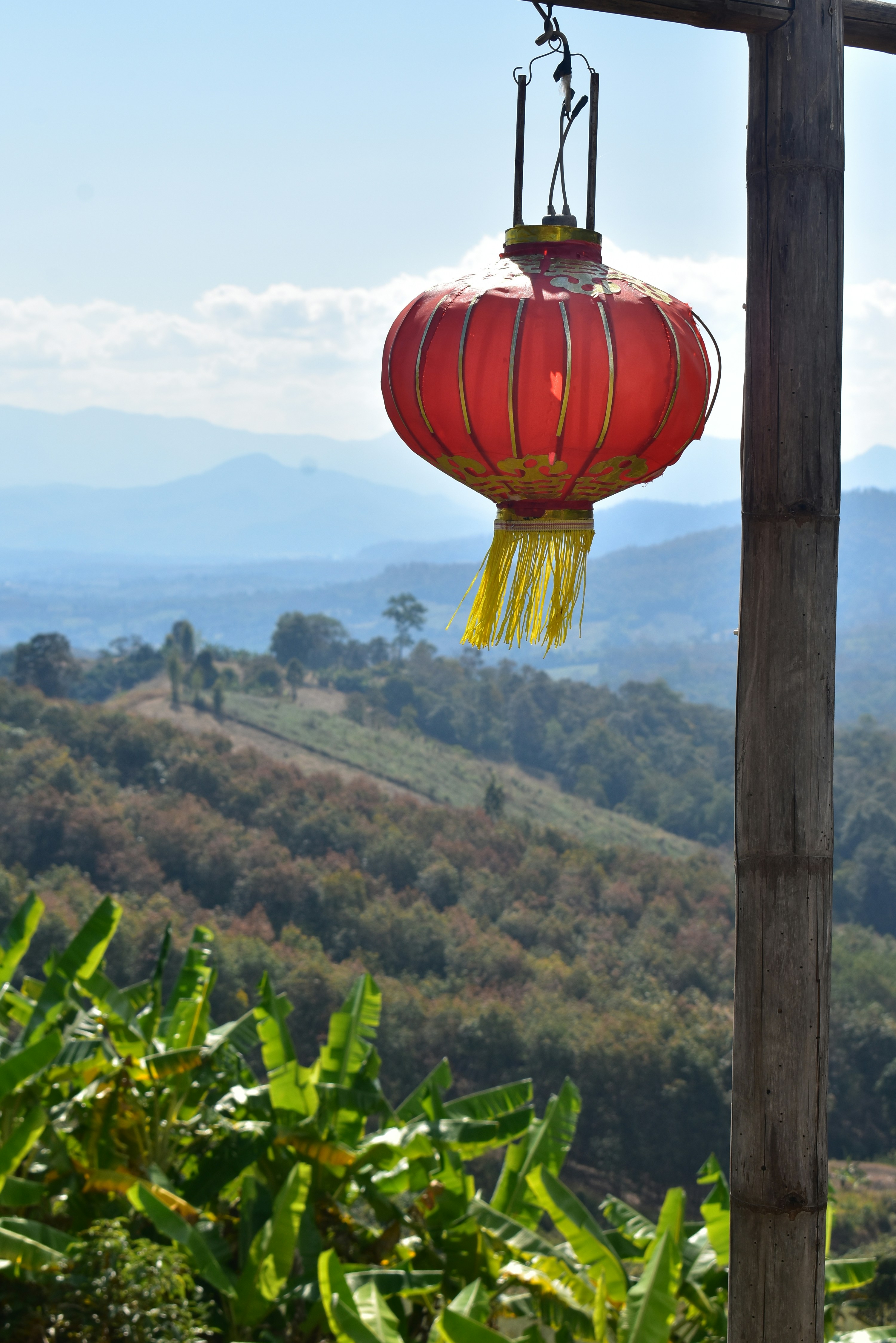 A red lantern hanging from a wooden pole photo – Free Thailand Image on ...