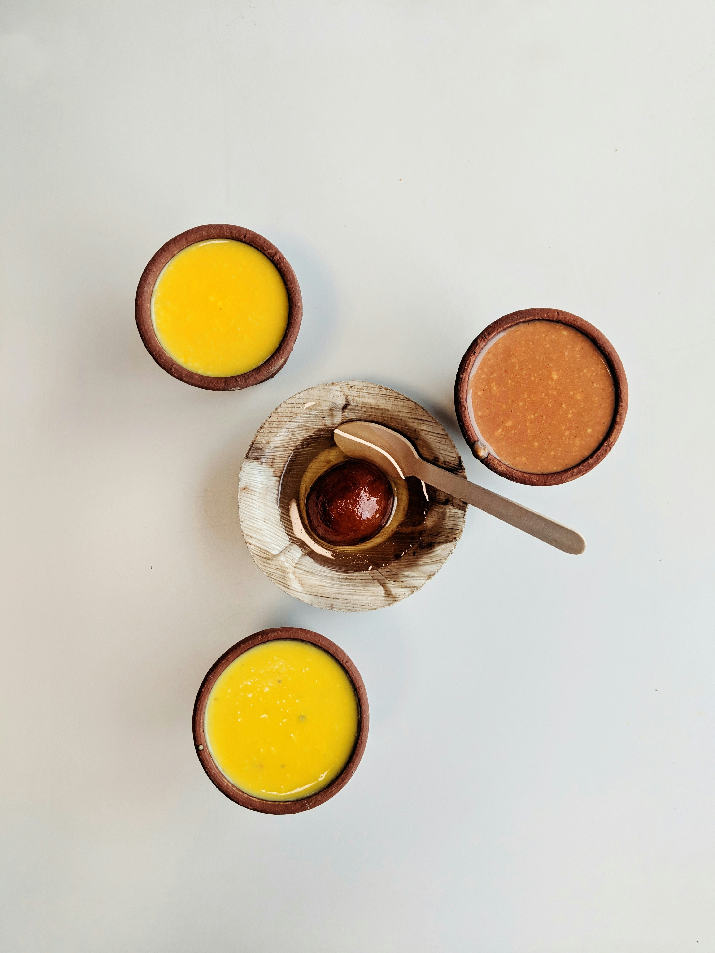 Triad of Sauces: Central Spoon Framing a Minimalist Palette