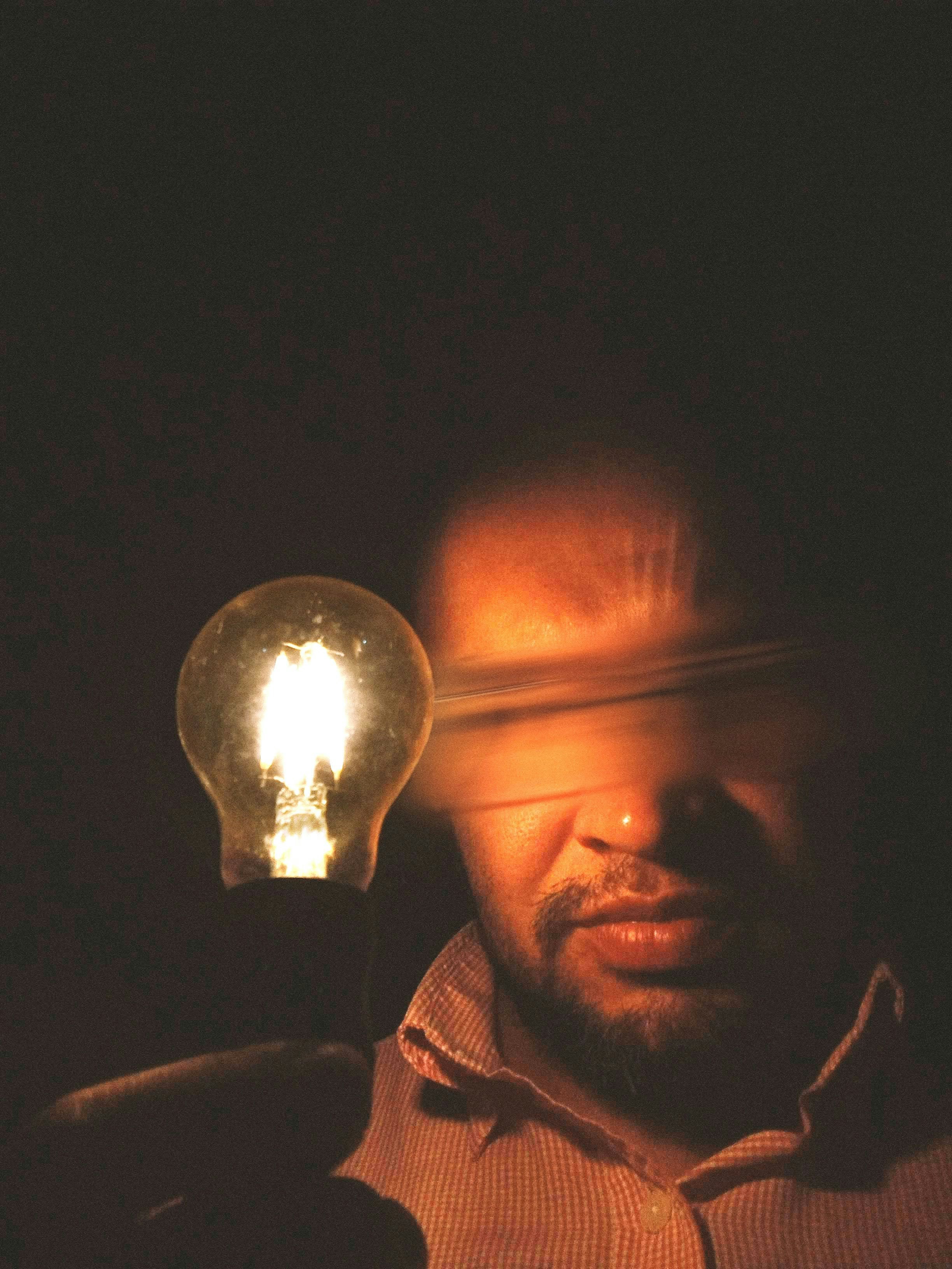a man holding a light bulb in his hand