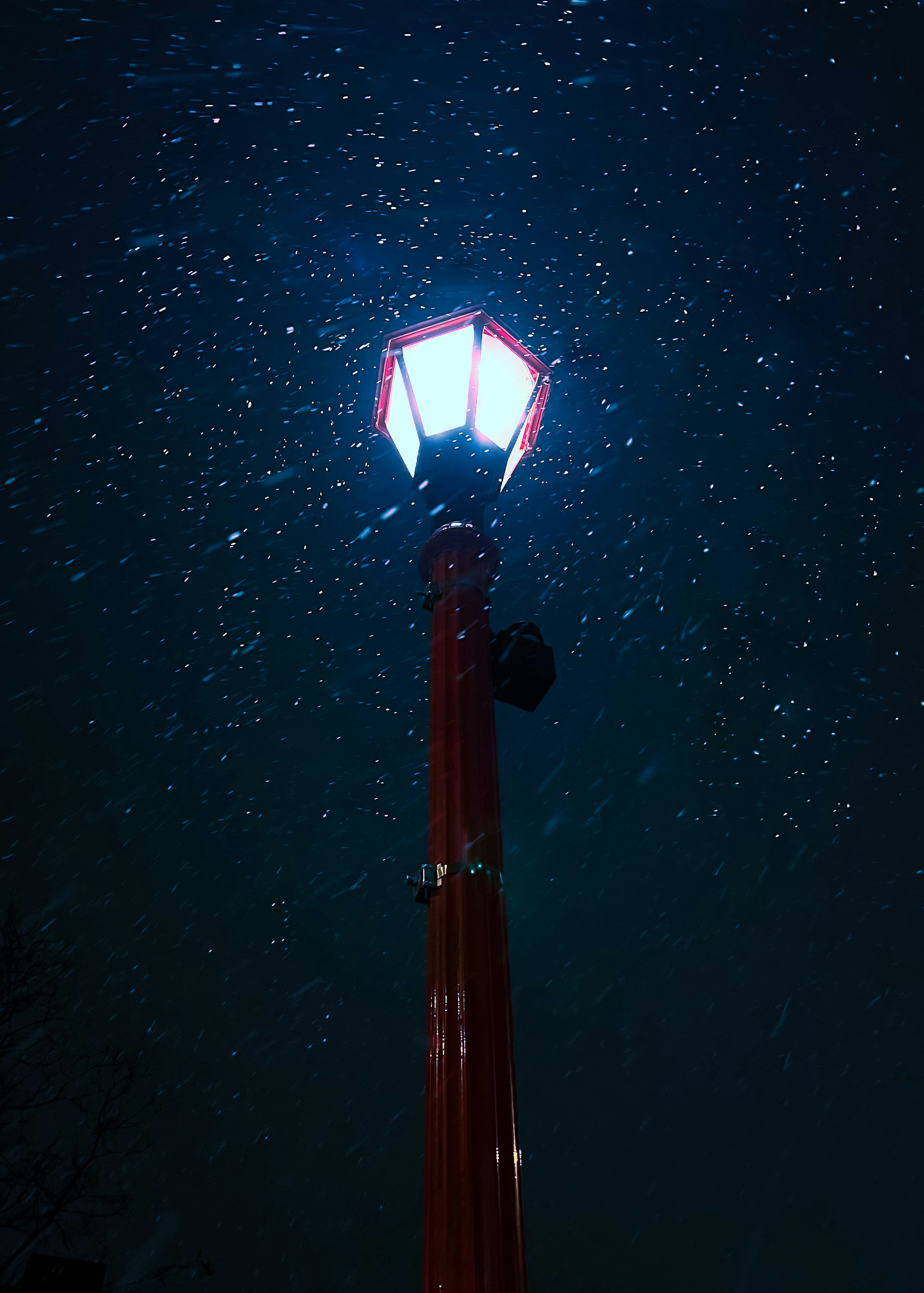 Glowing Lantern Beneath a Snowy Night