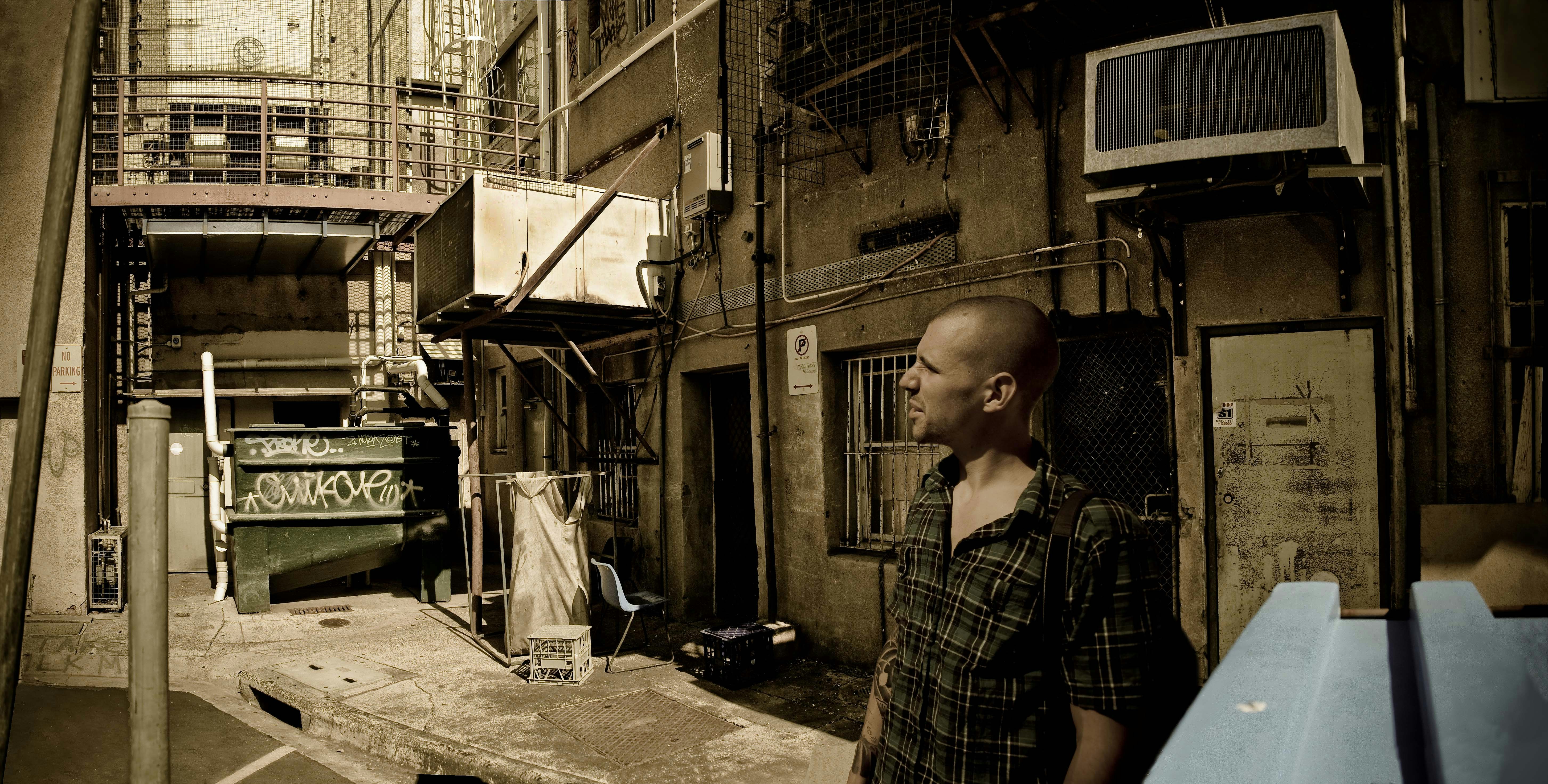 A man standing in a narrow alley way photo – Free Gritty home Image on ...
