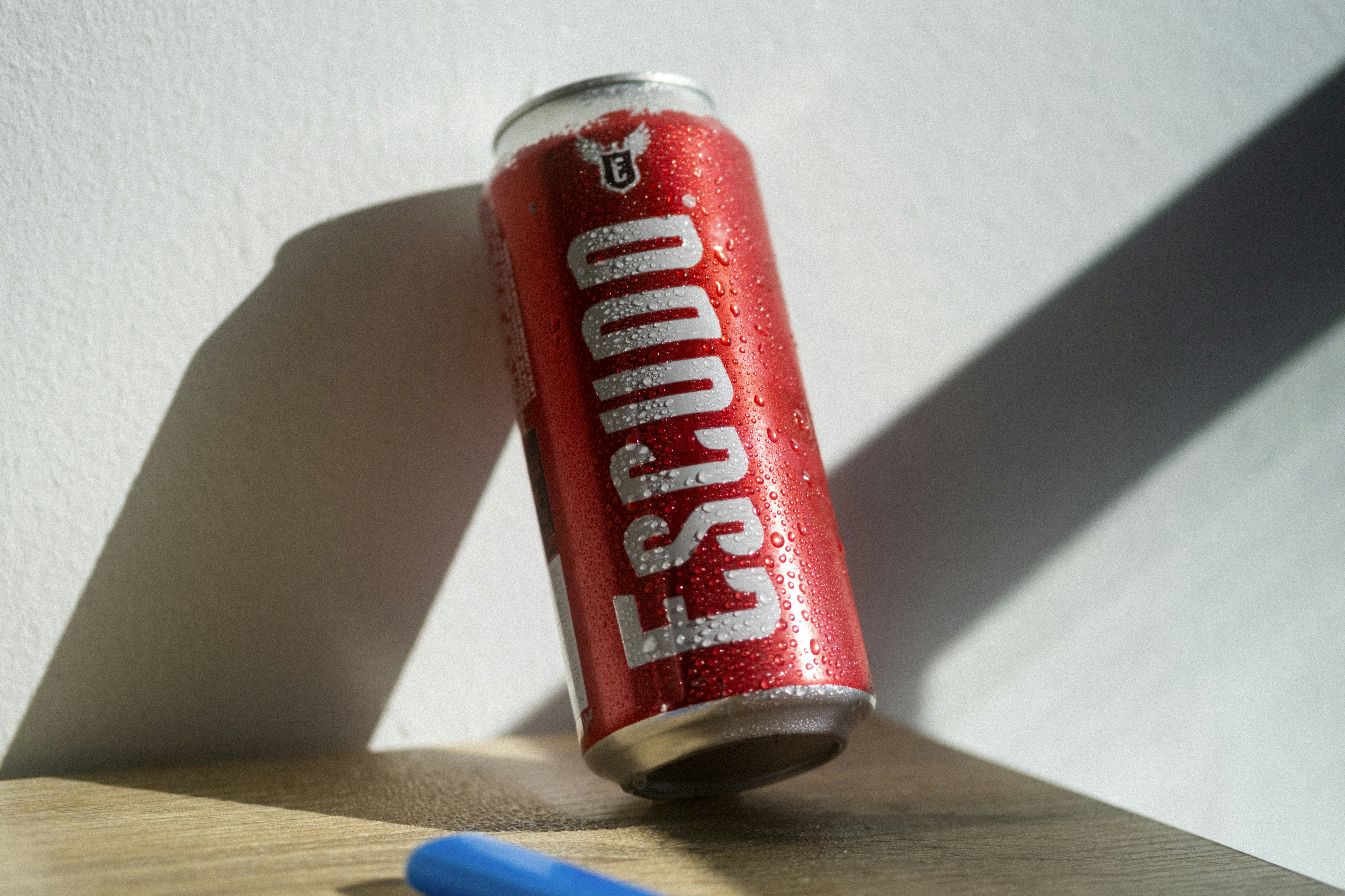 Lean of Red Aluminum: A Sunlit Soda Can on a Wooden Desk