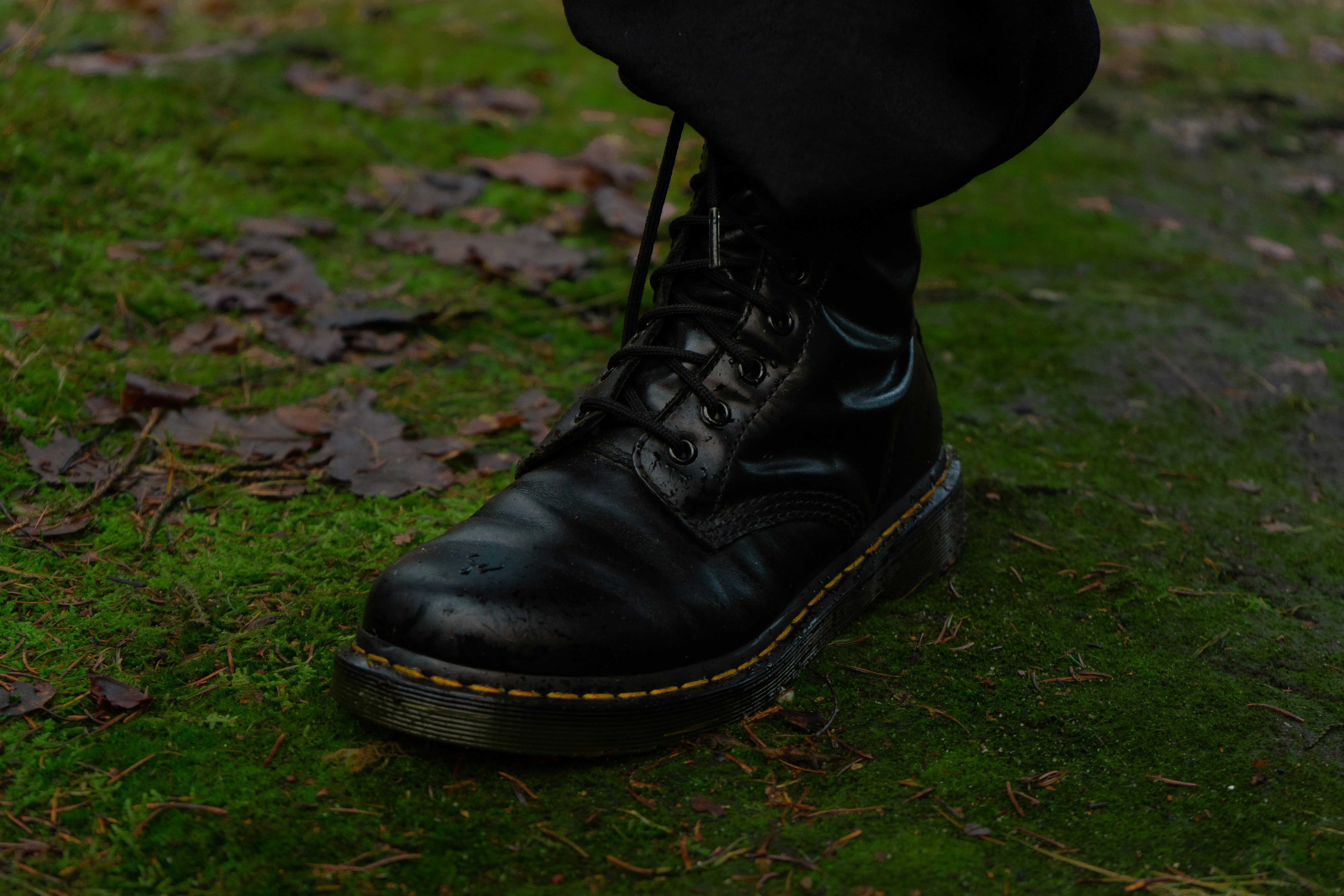 a close up of a person wearing black shoes