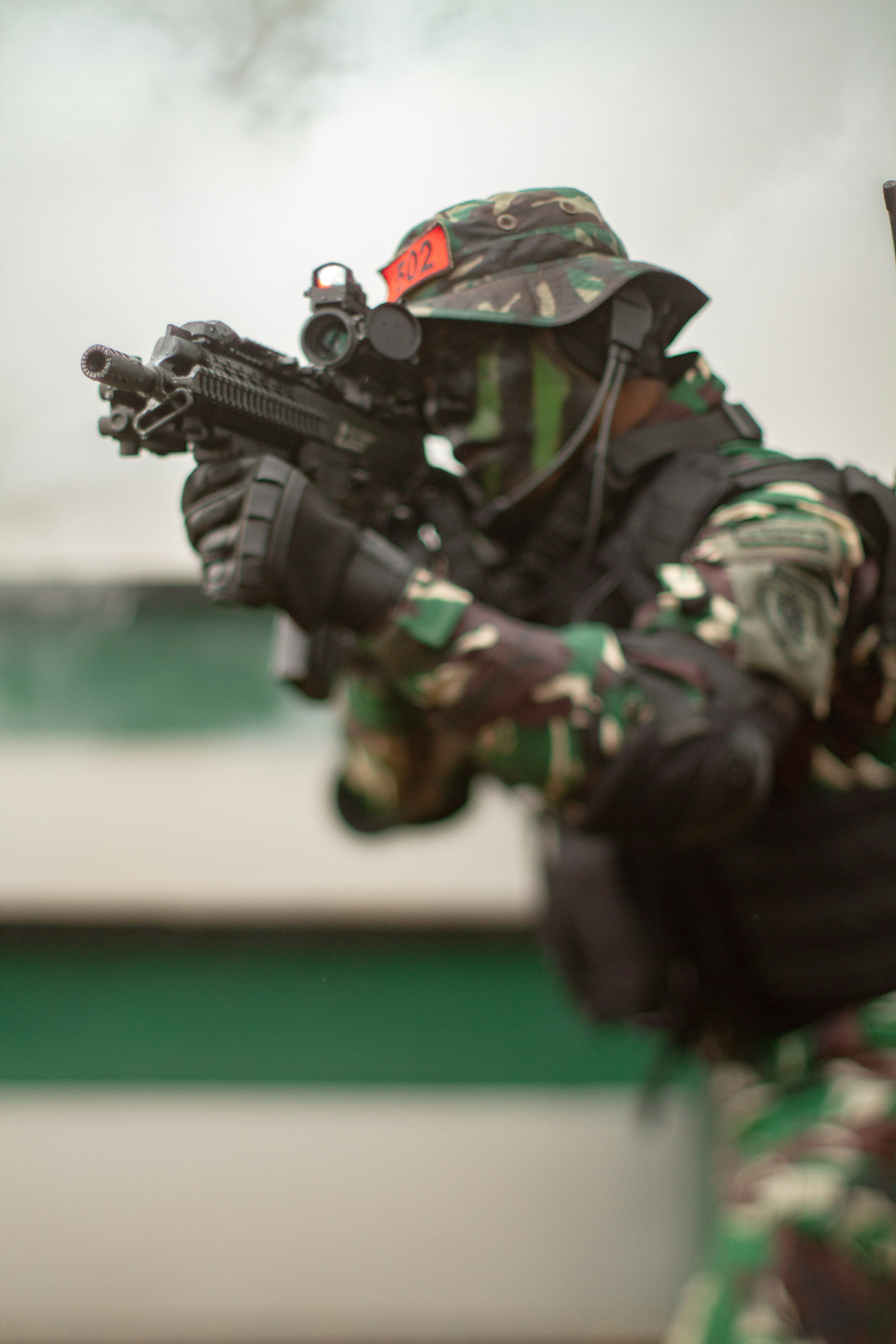 Shallow Focus, Steady Aim: Camouflaged Rifleman in Close Quarters