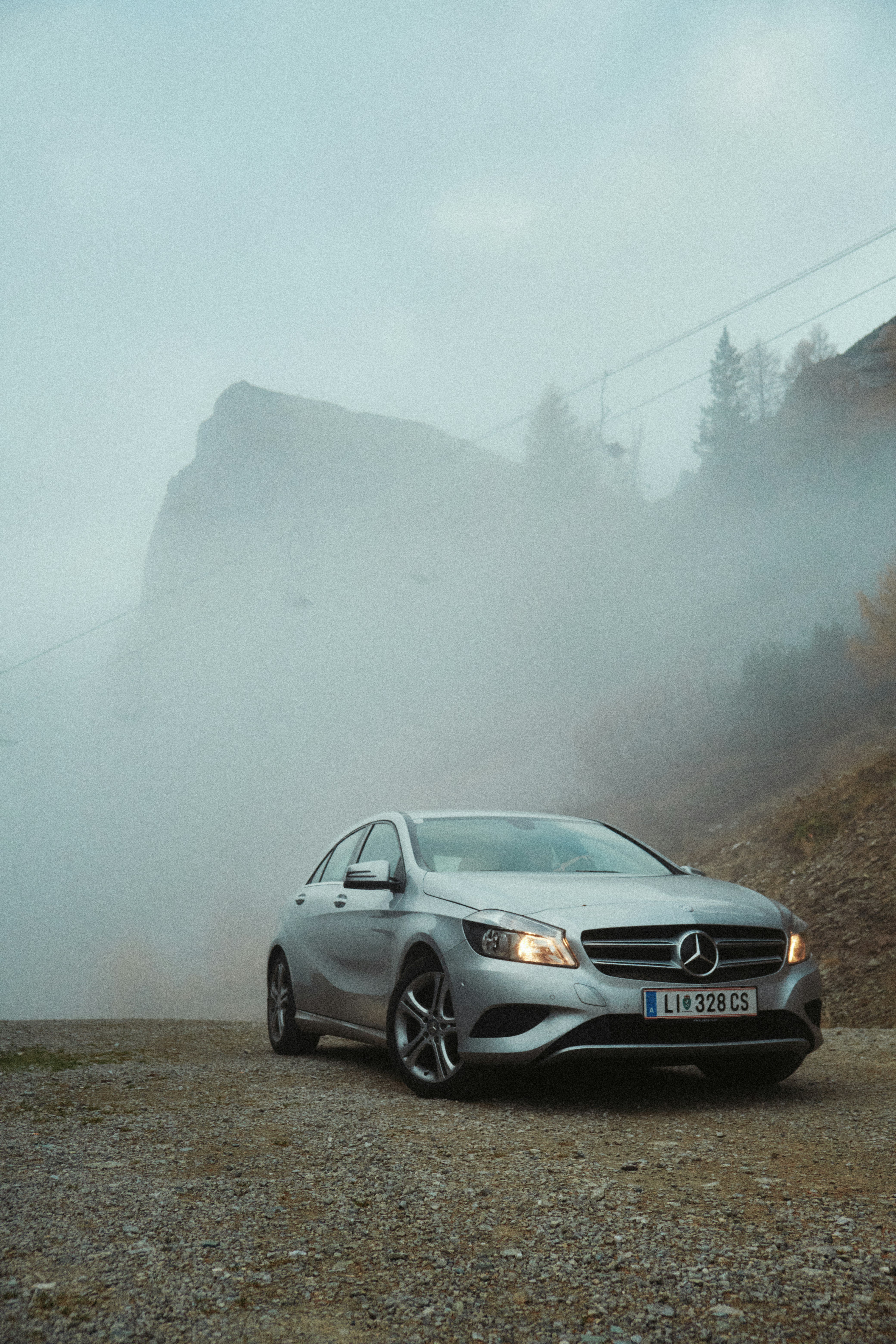 Mist and Mercedes: Car Parked on a Fog-washed Mountain Road