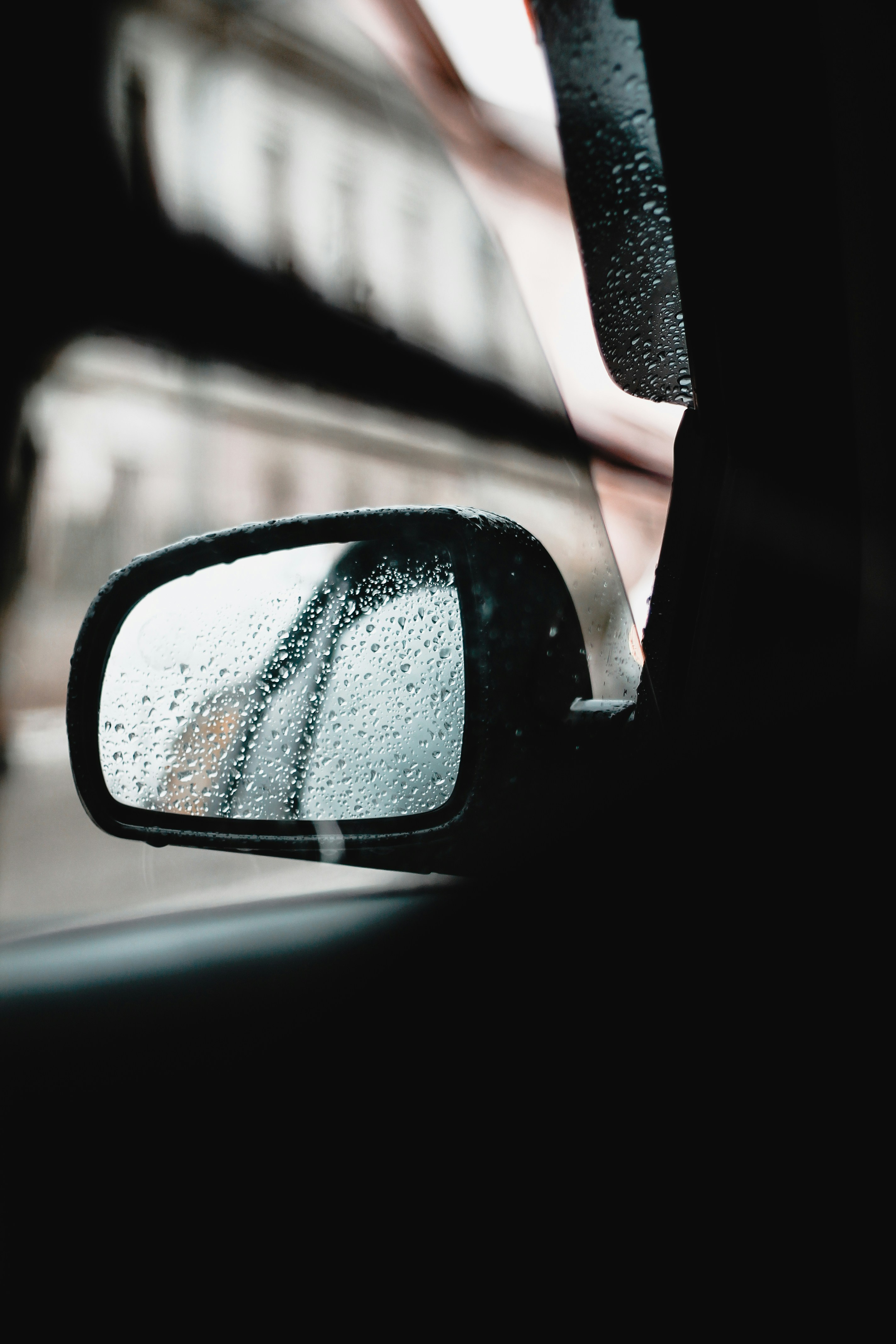 a rear view mirror with rain drops on it
