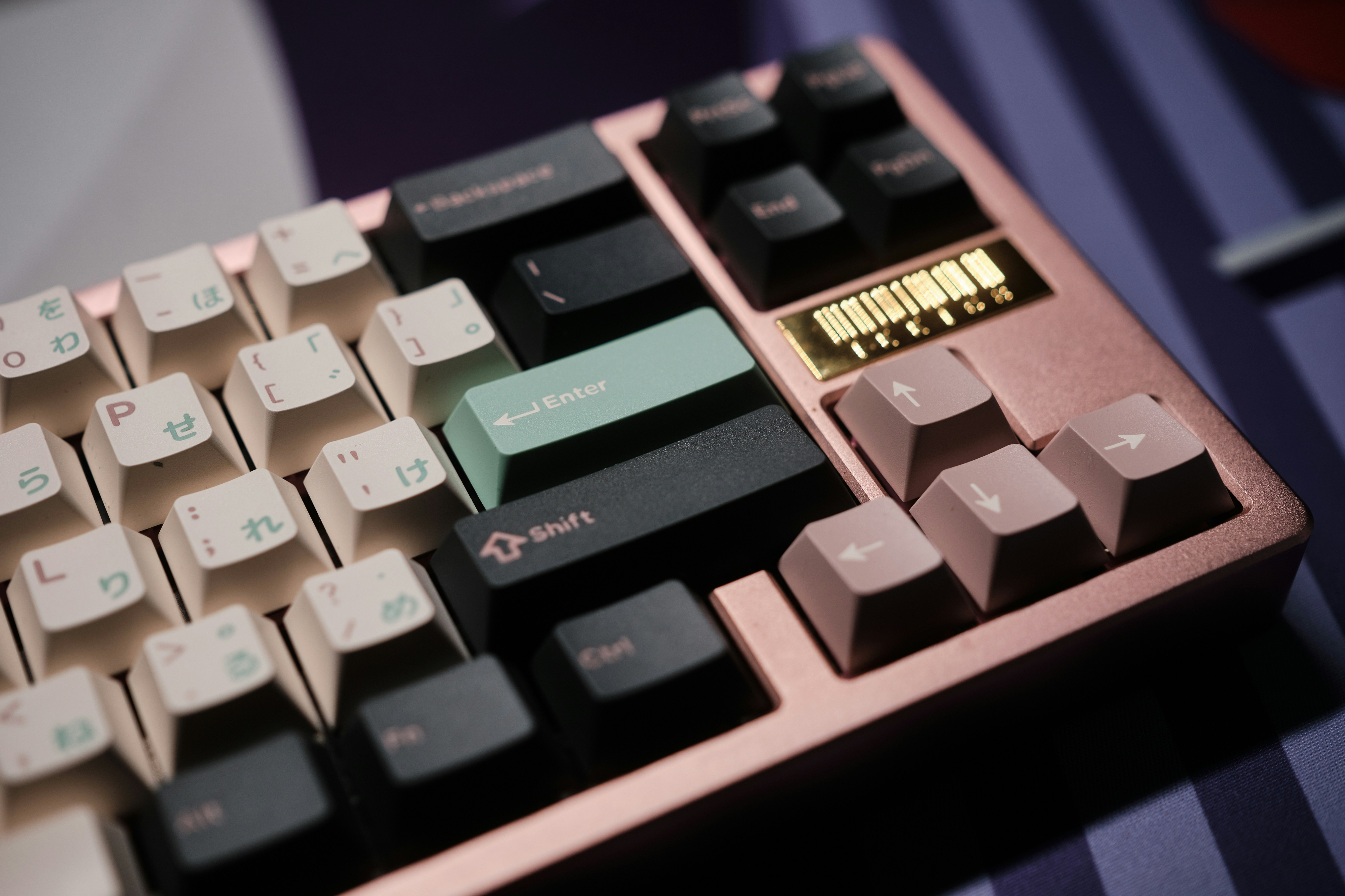 Emerald Keycap Amid the Rose-Gold Frame: Close-Up on a Mechanical Keyboard