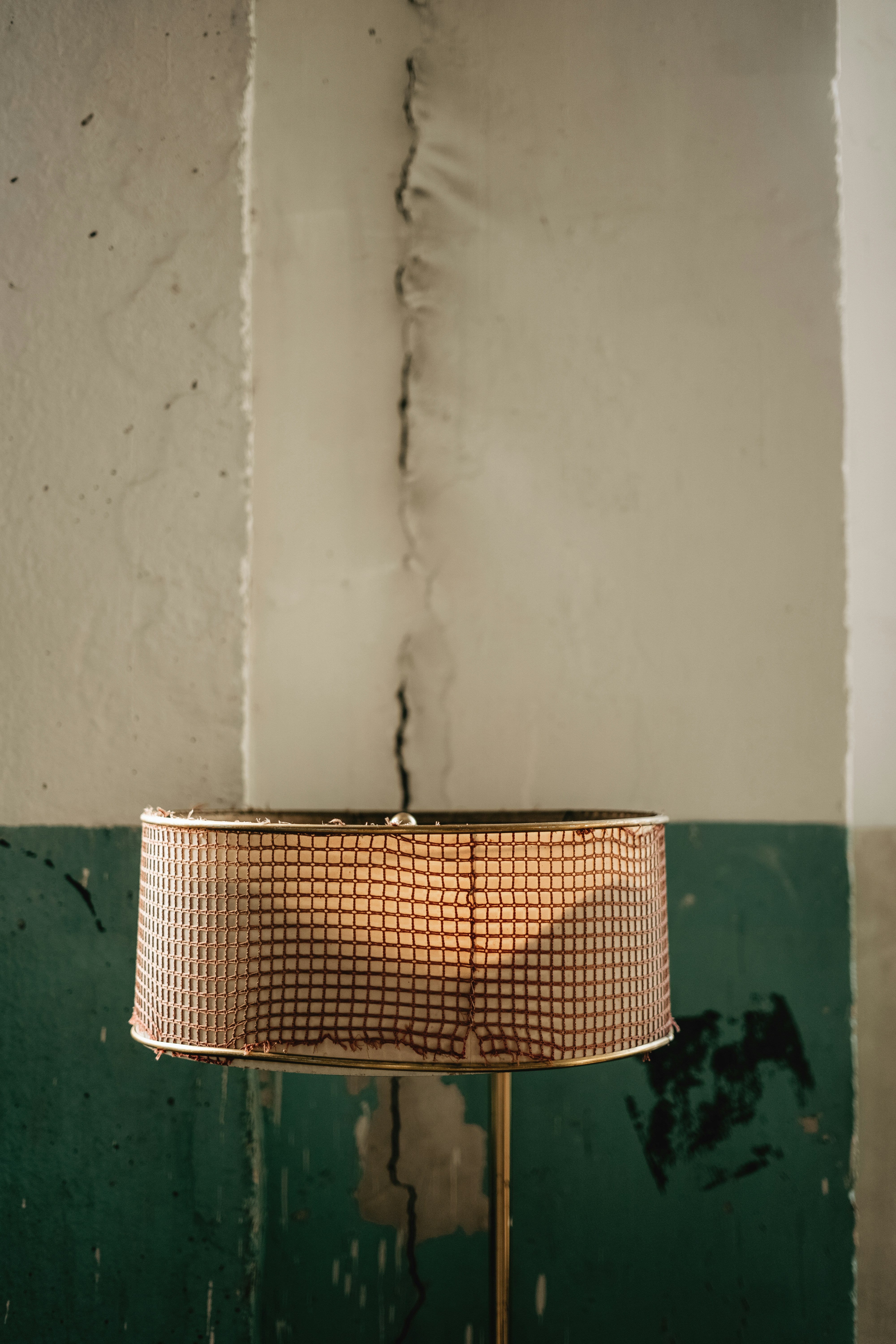 Copper Mesh Lampshade in a Cracked-Wall Nook