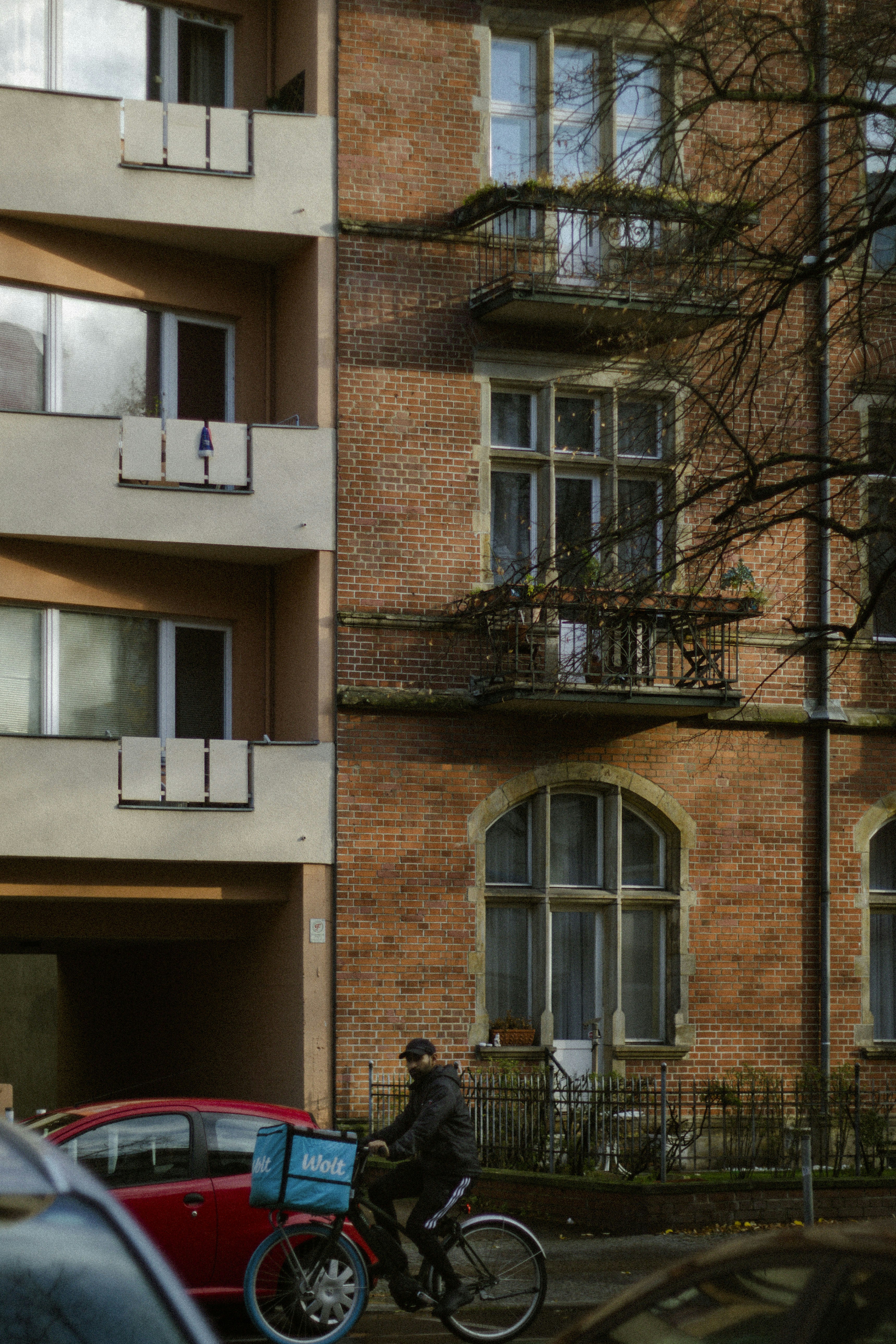 Blue-Bag Courier on a Brick-Fronted Street