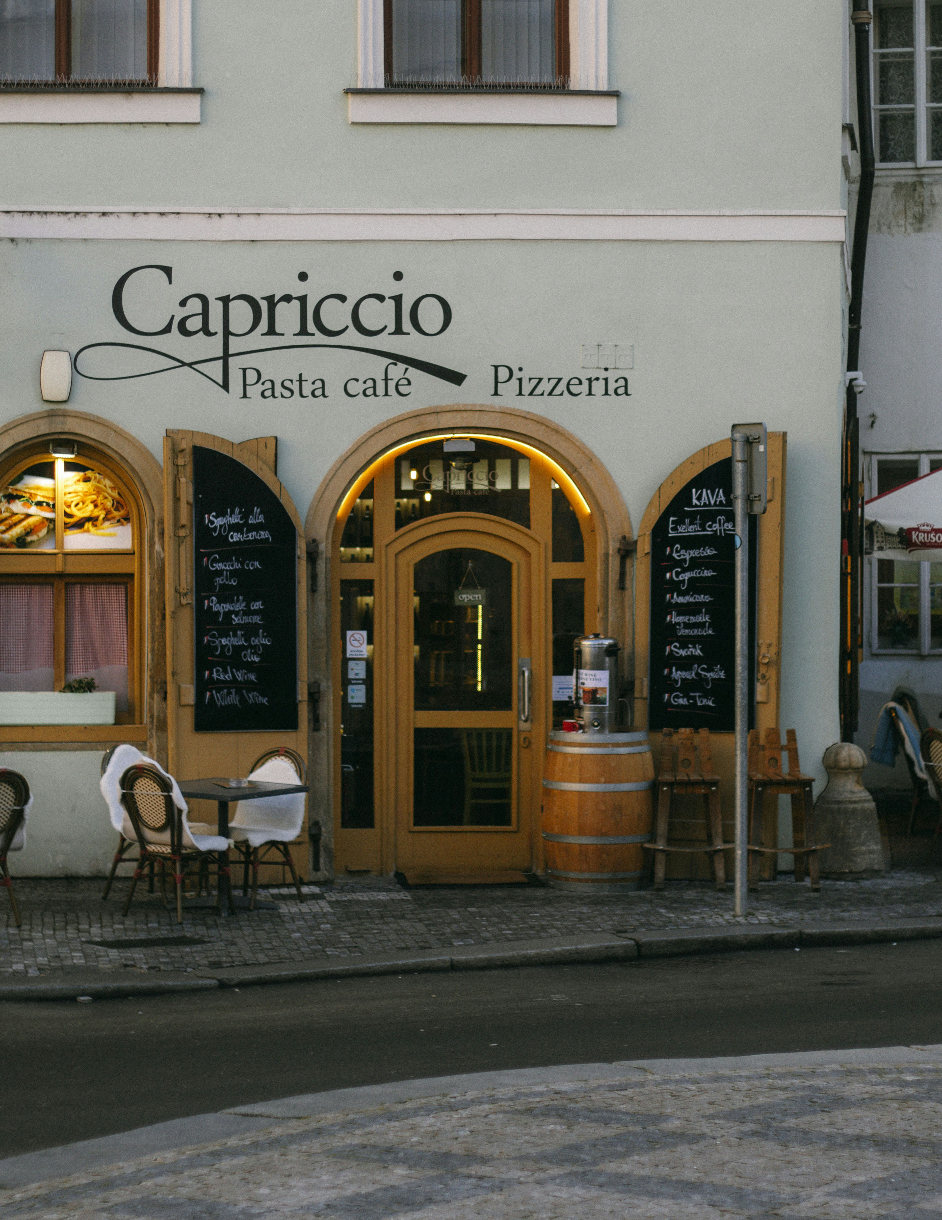 Amber Arches of Capriccio: A Pizzeria on the Cobblestoned Street