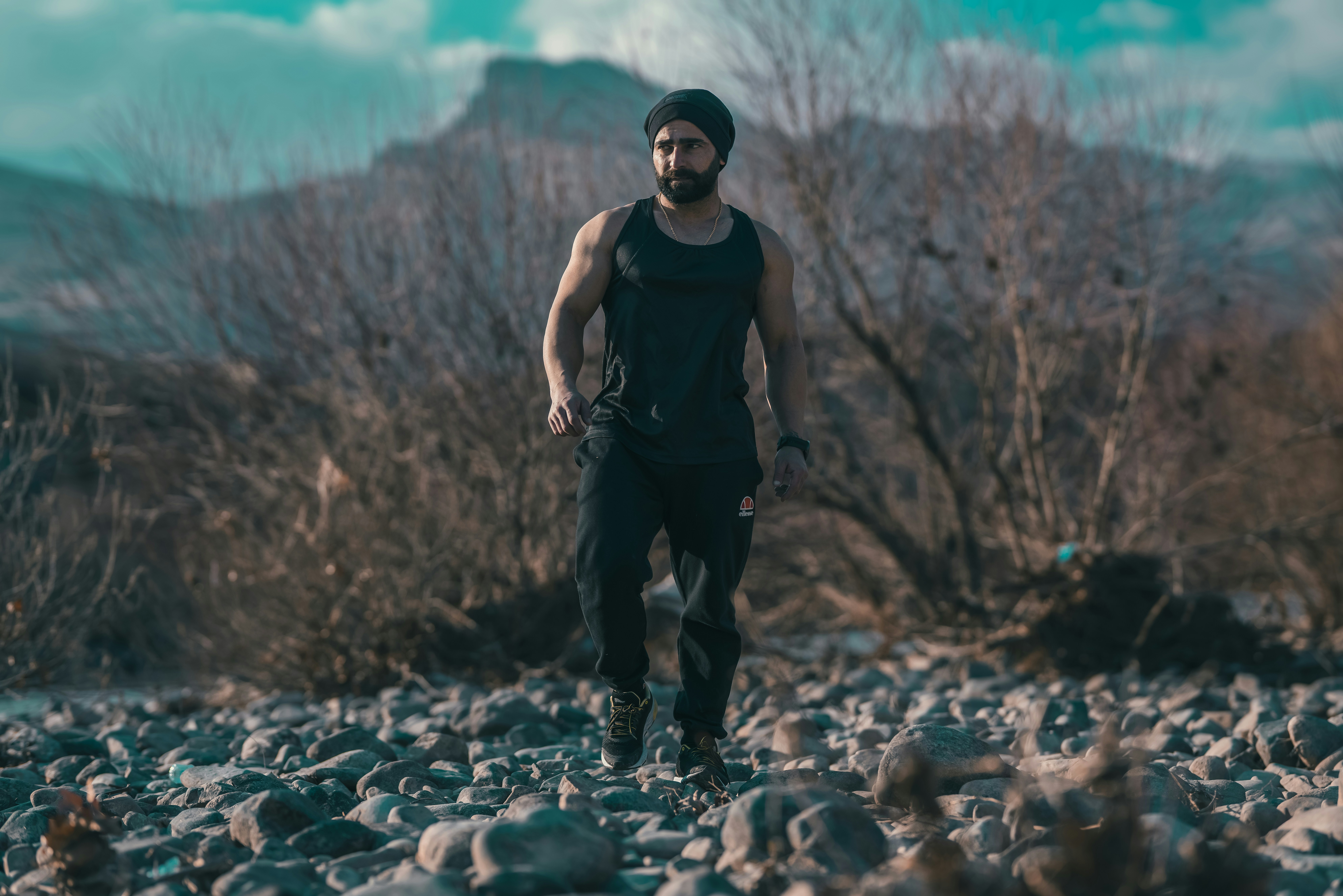 A man with a beard is running on rocks photo – Free Human Image on Unsplash