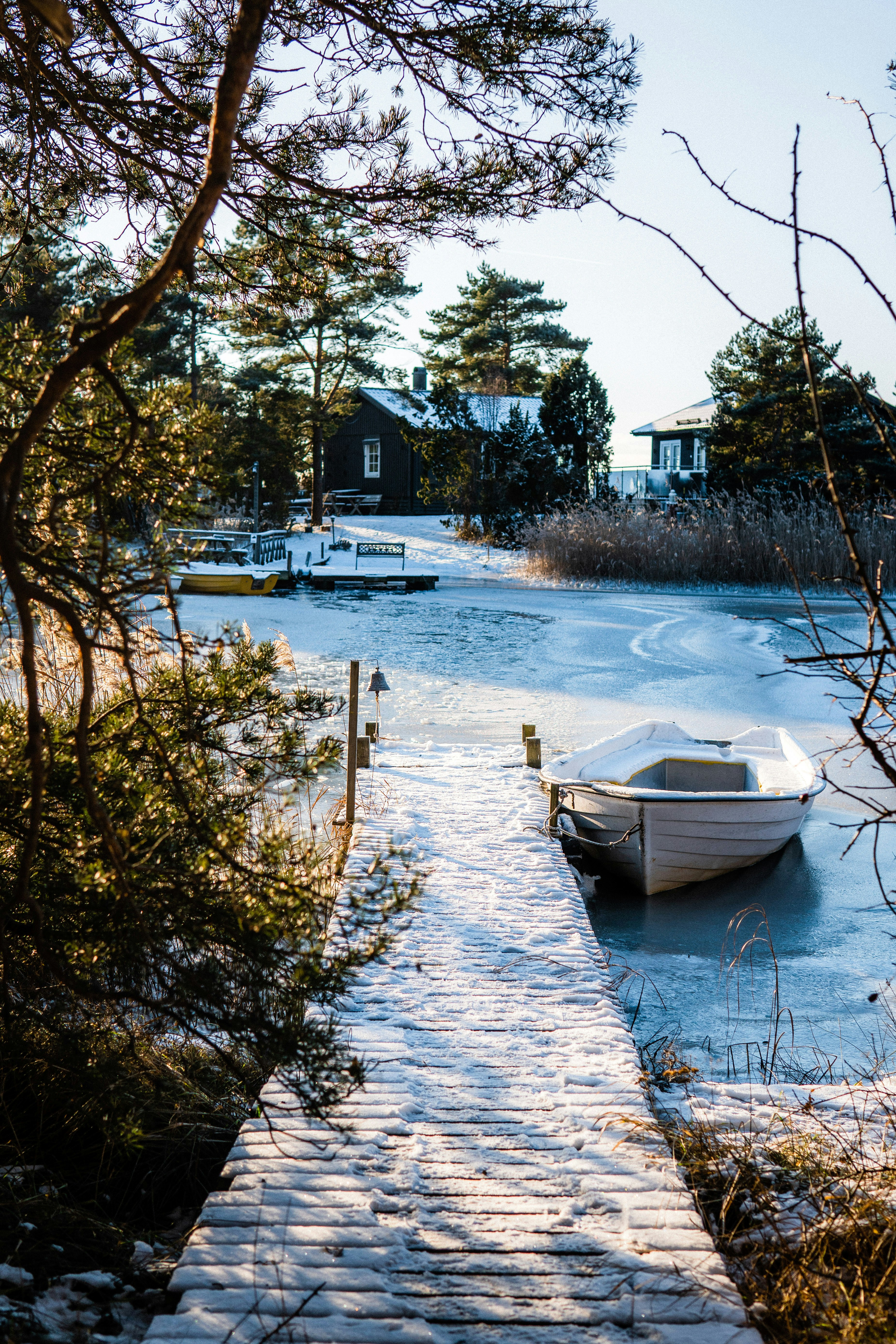 Snow-Glazed Dock Framing a Quiet Lakeside Boat