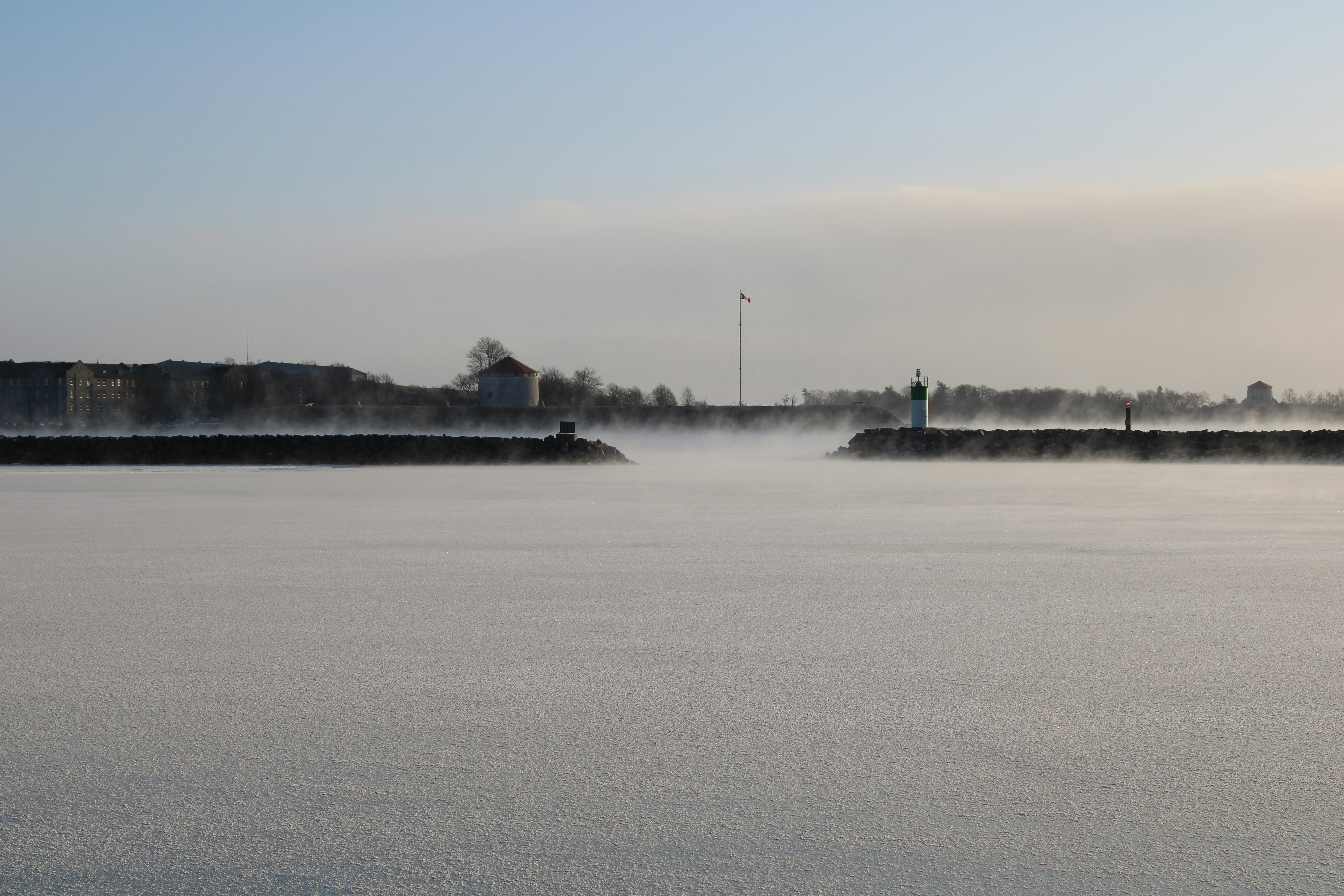 Mist-veiled Breakwater at Dawn: Winter Harbor Portrait