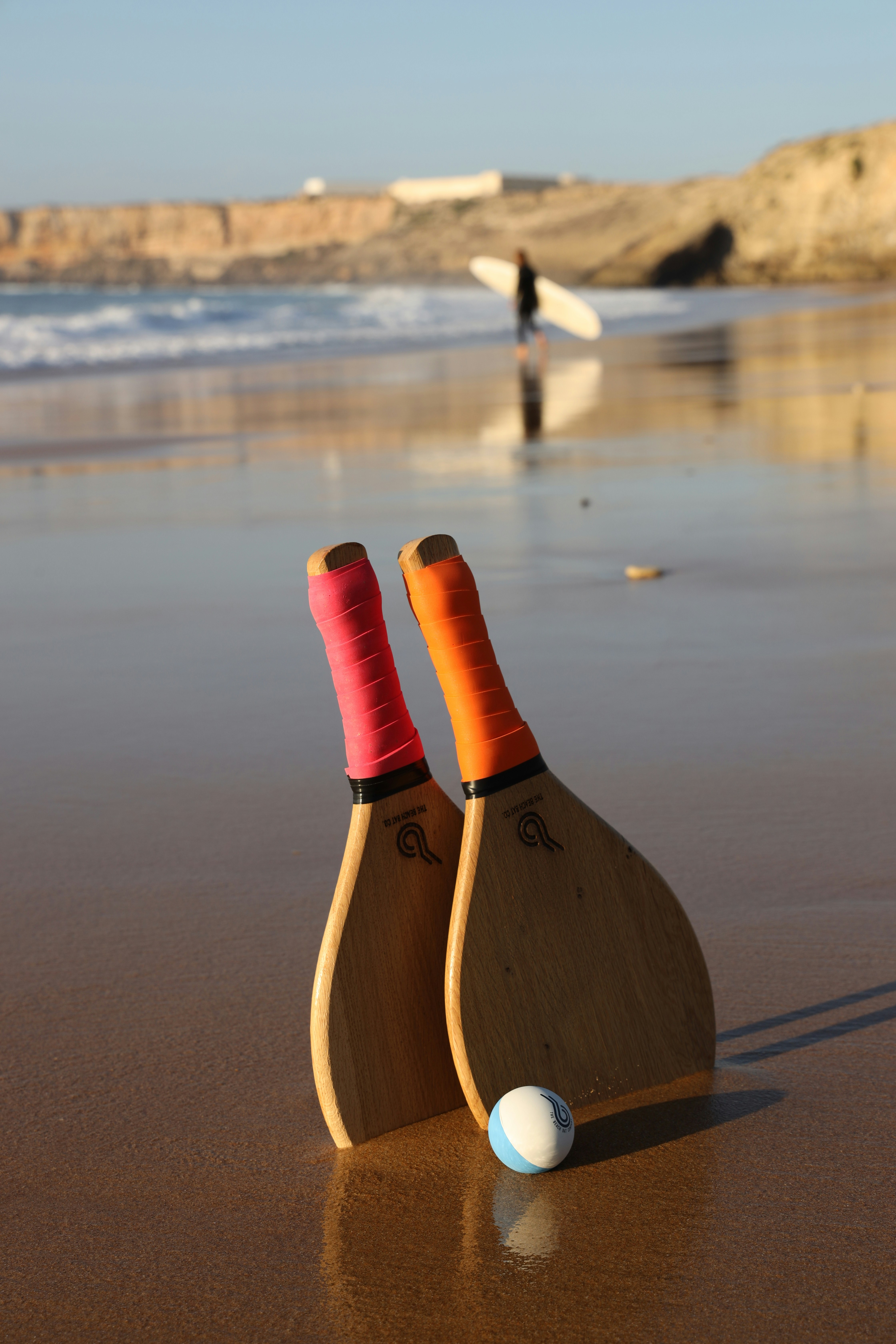 a couple of paddles sitting on top of a sandy beach
