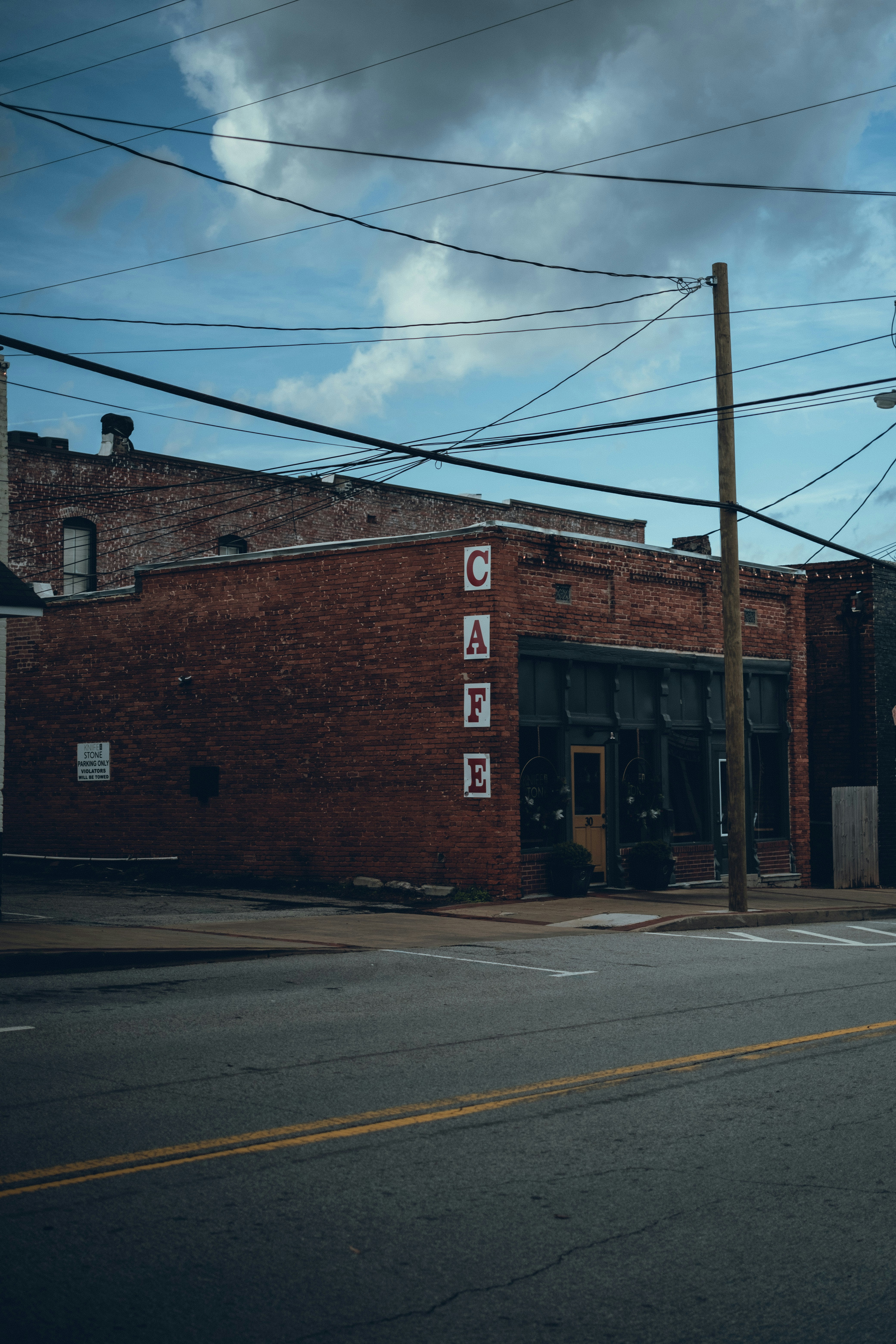 A red brick building sitting on the side of a road photo – Free Newnan ...