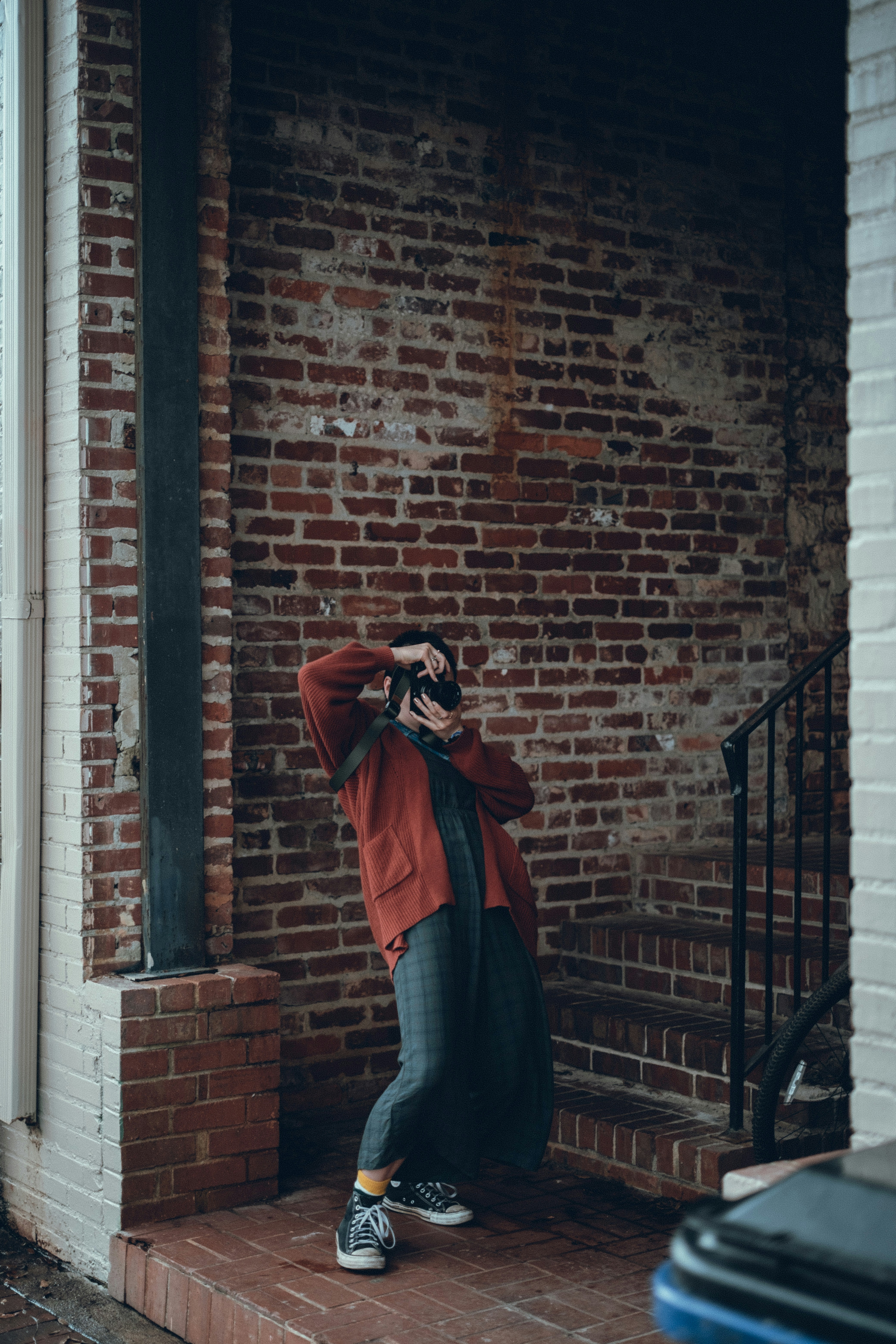 A woman standing on a porch talking on a cell phone photo – Free Newnan ...