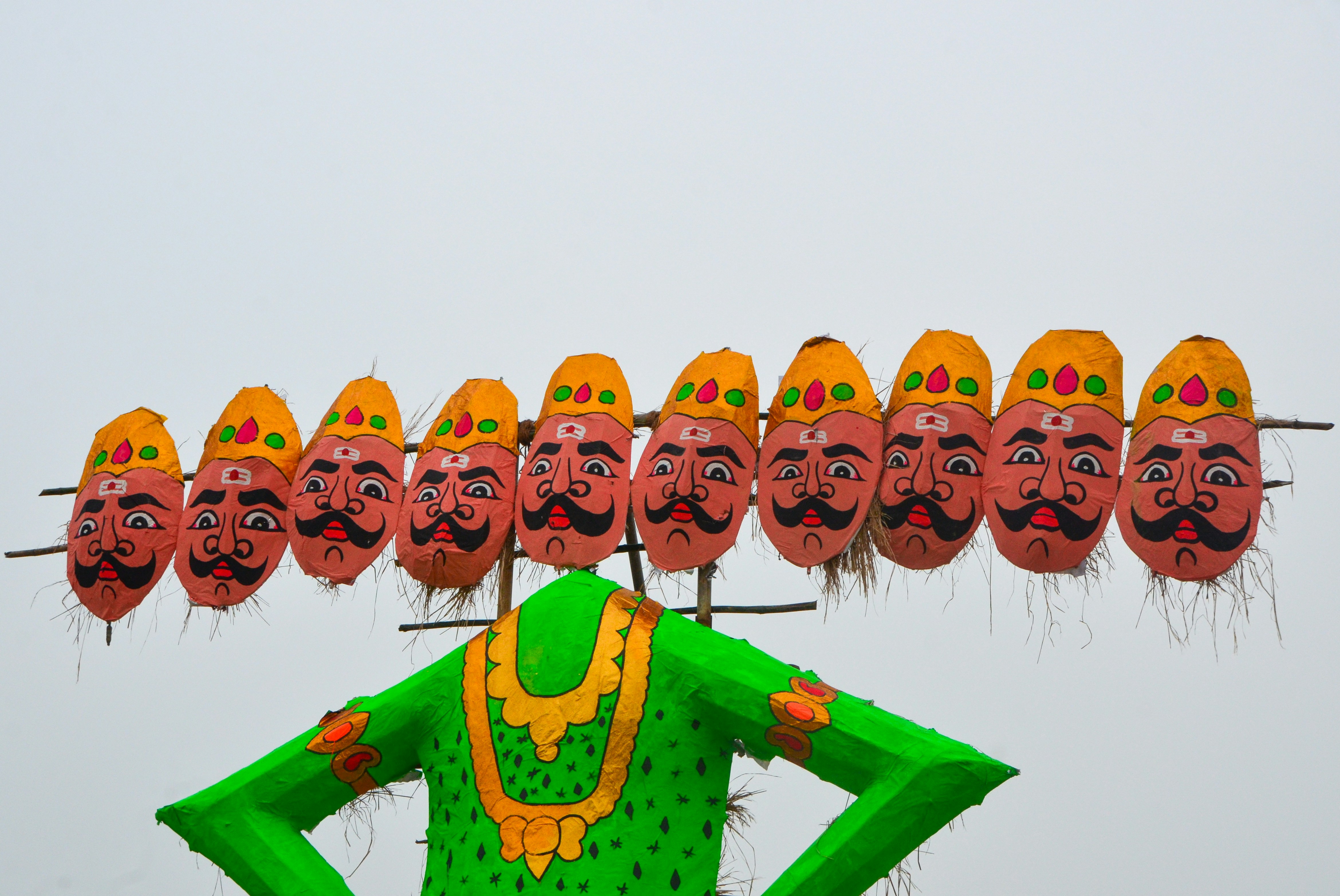 a woman standing in front of a display of masks