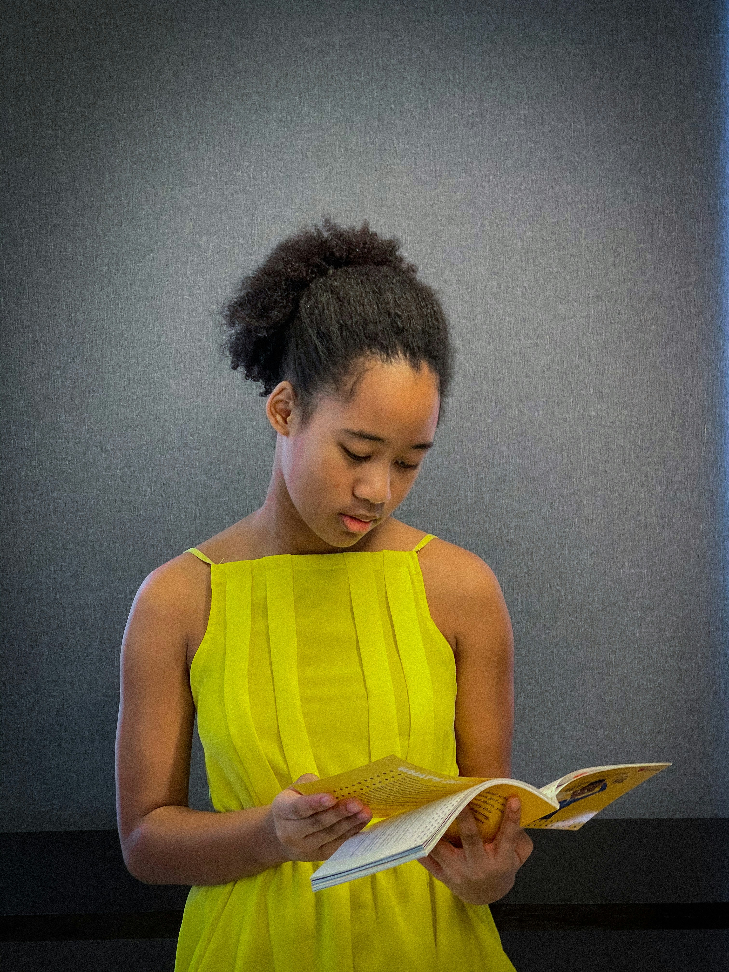A woman in a yellow dress reading a book photo – Free Portrait Image on ...